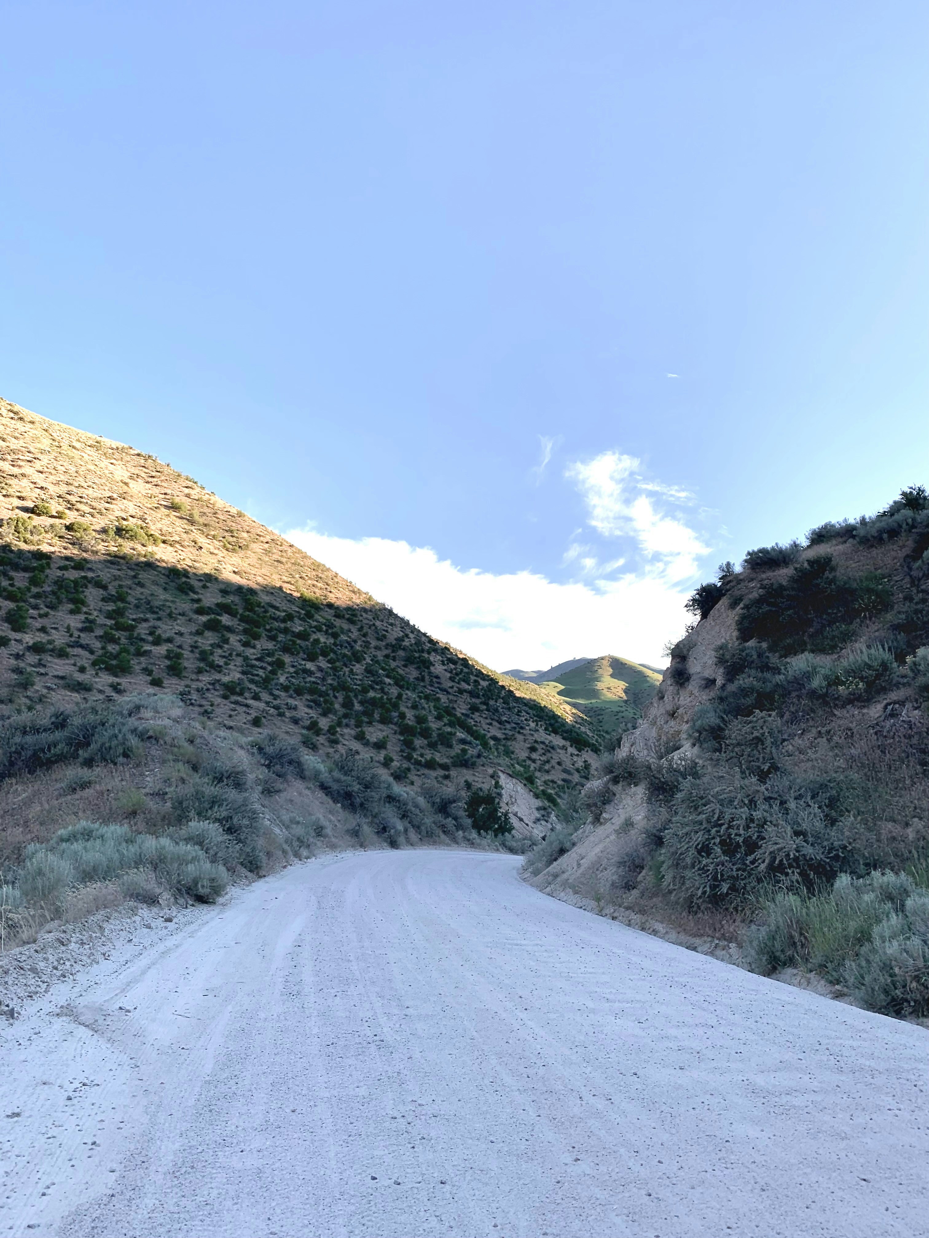 Dusty Descent: A Gravel Path Carves Through Sunlit Canyon