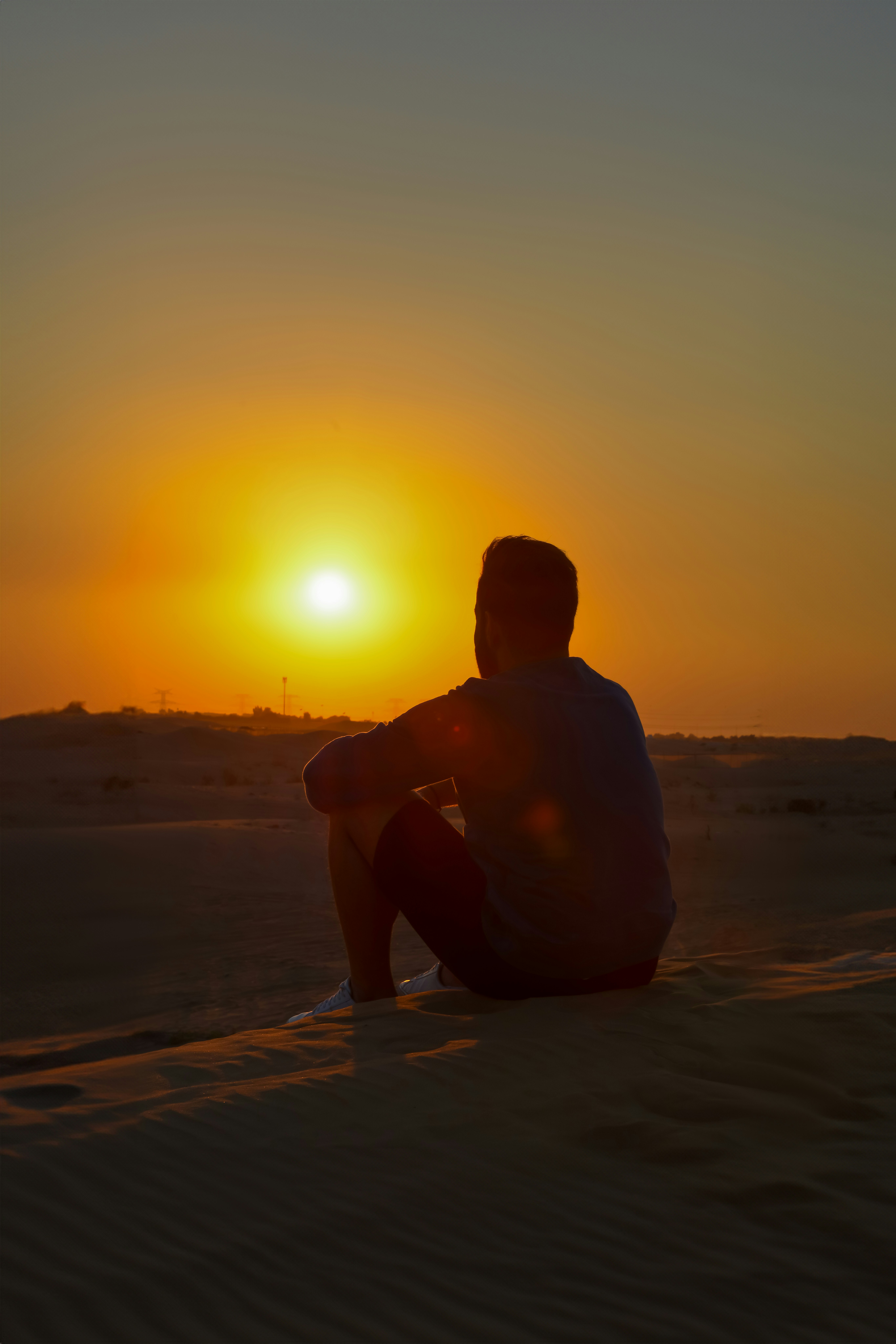 Desert Dusk: A Solitary Silhouette on the Wind-Carved Dunes