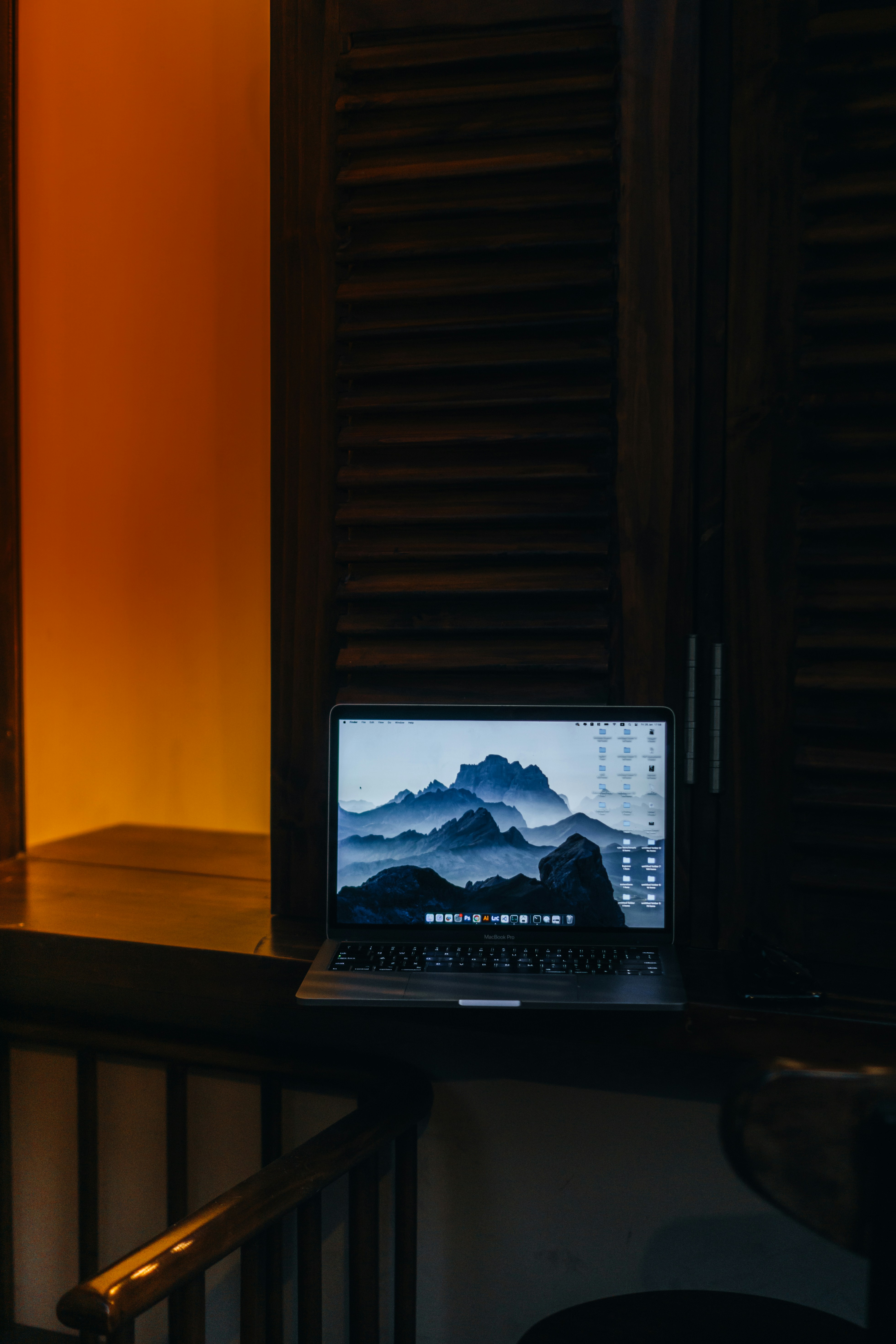 Amber Glow and Mountain Desktop: A Laptop in a Quiet Studio