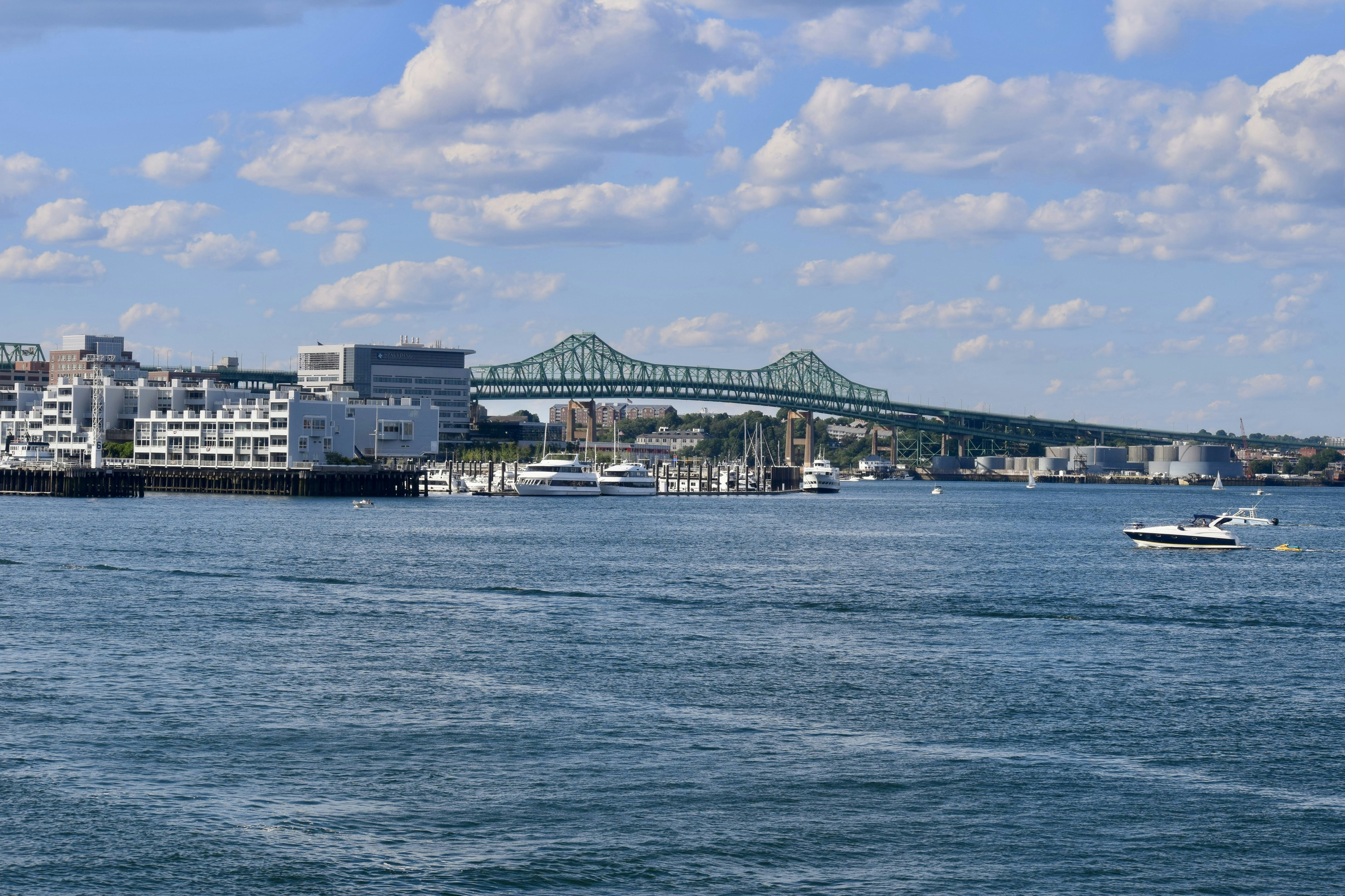 Emerald Arches Over the Harbor: Boats Under a Green Steel Bridge