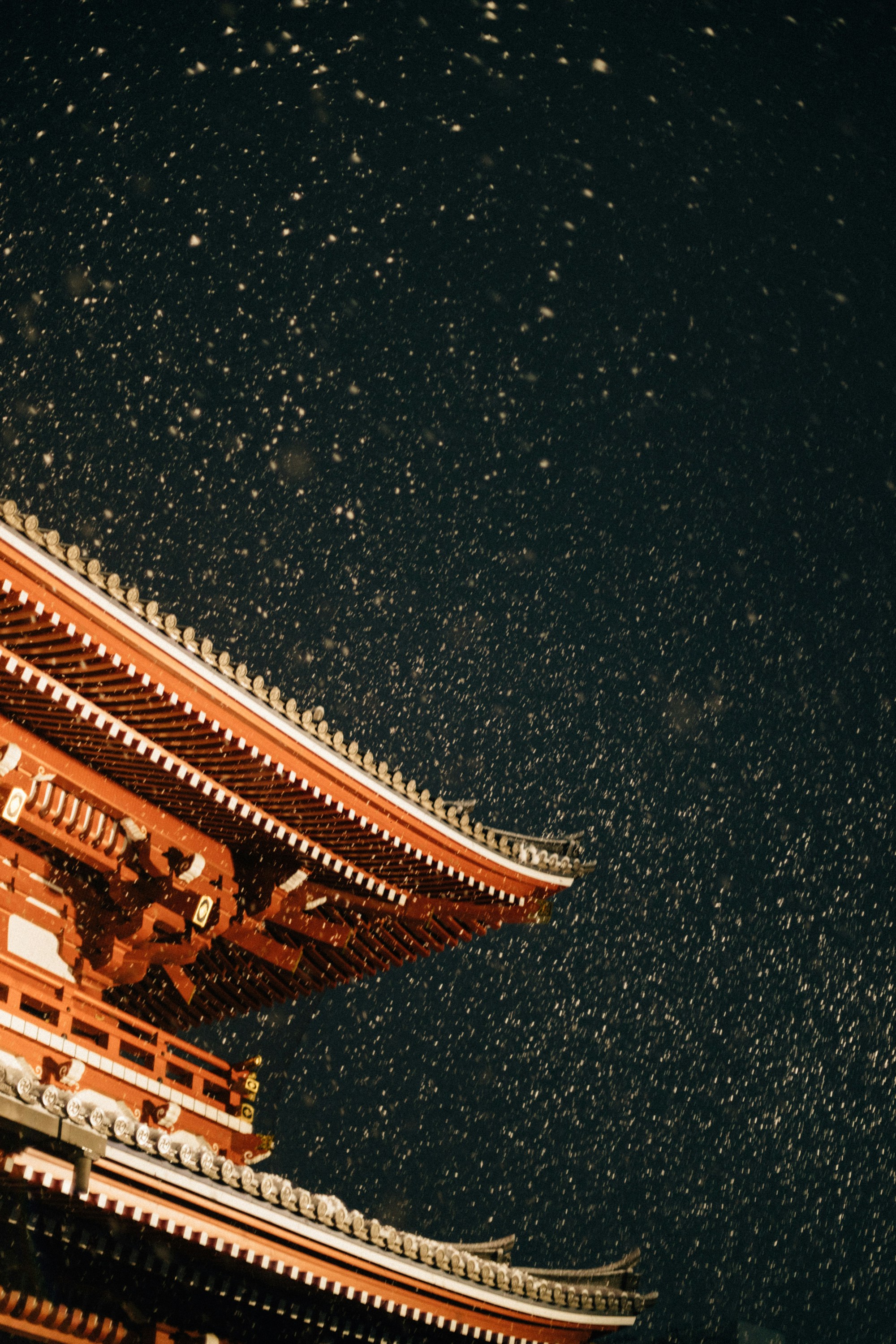 A building with snow falling from the roof photo – Free Night Image on ...