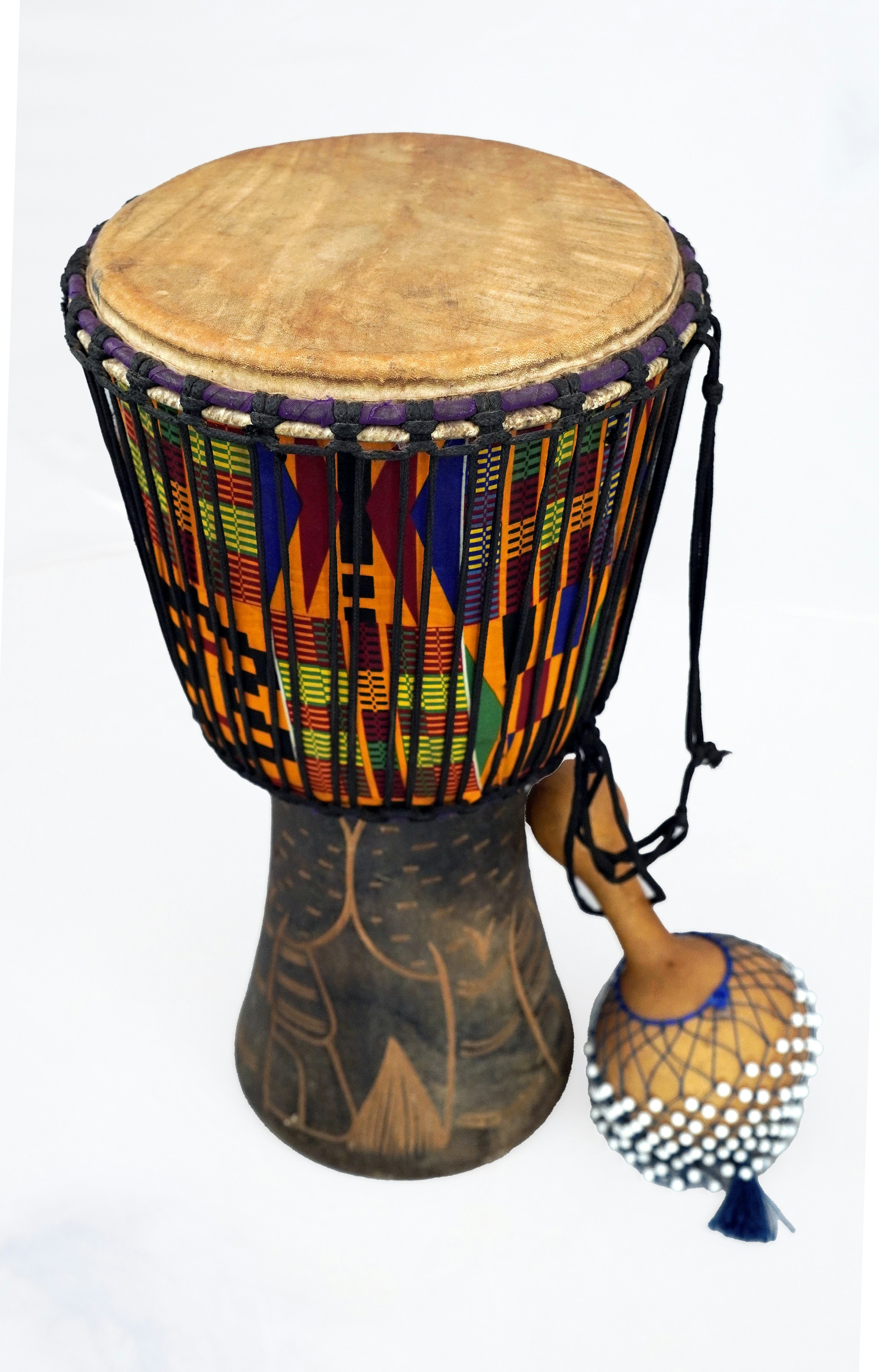 Kente-Patterned Djembe: A Colorful Drum Against White Studio Light