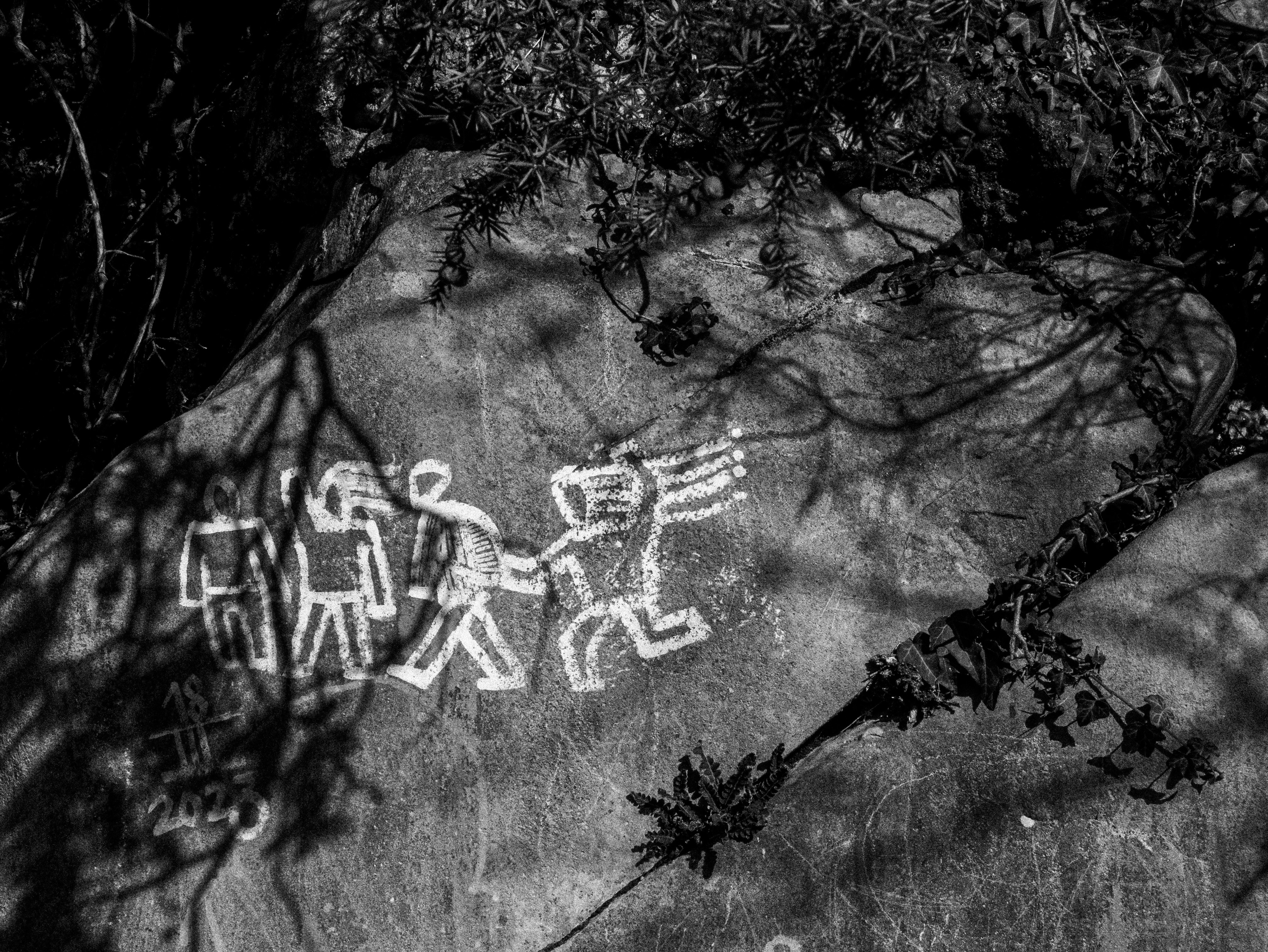 Chalked Stick Figures on a Shadowed Wall
