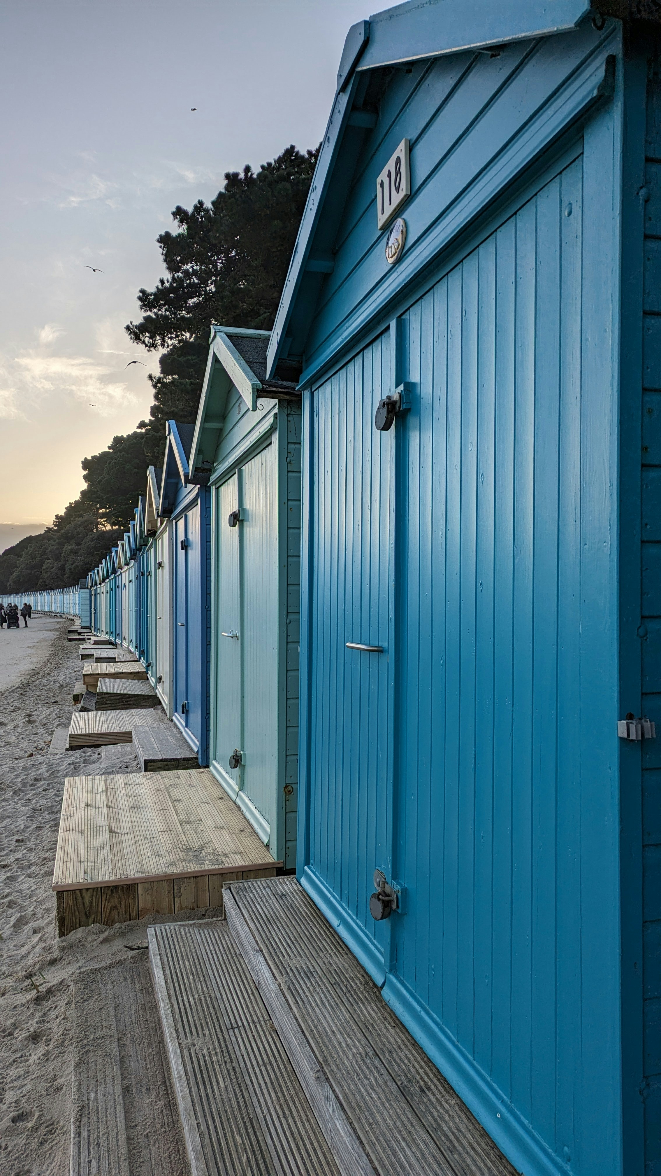 A row of beach huts sitting next to each other photo – Free Beach Image ...