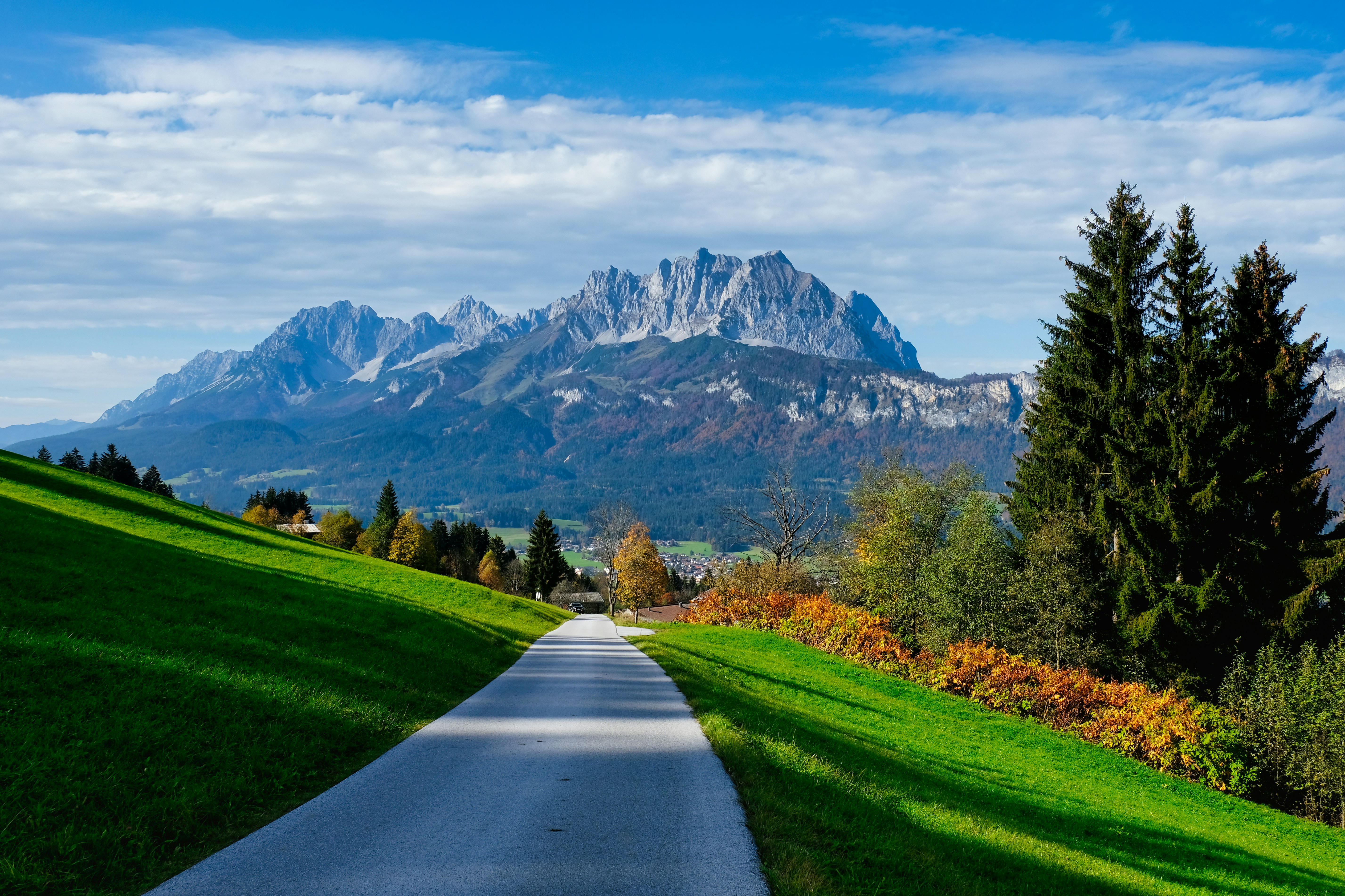 a long road with a mountain in the background