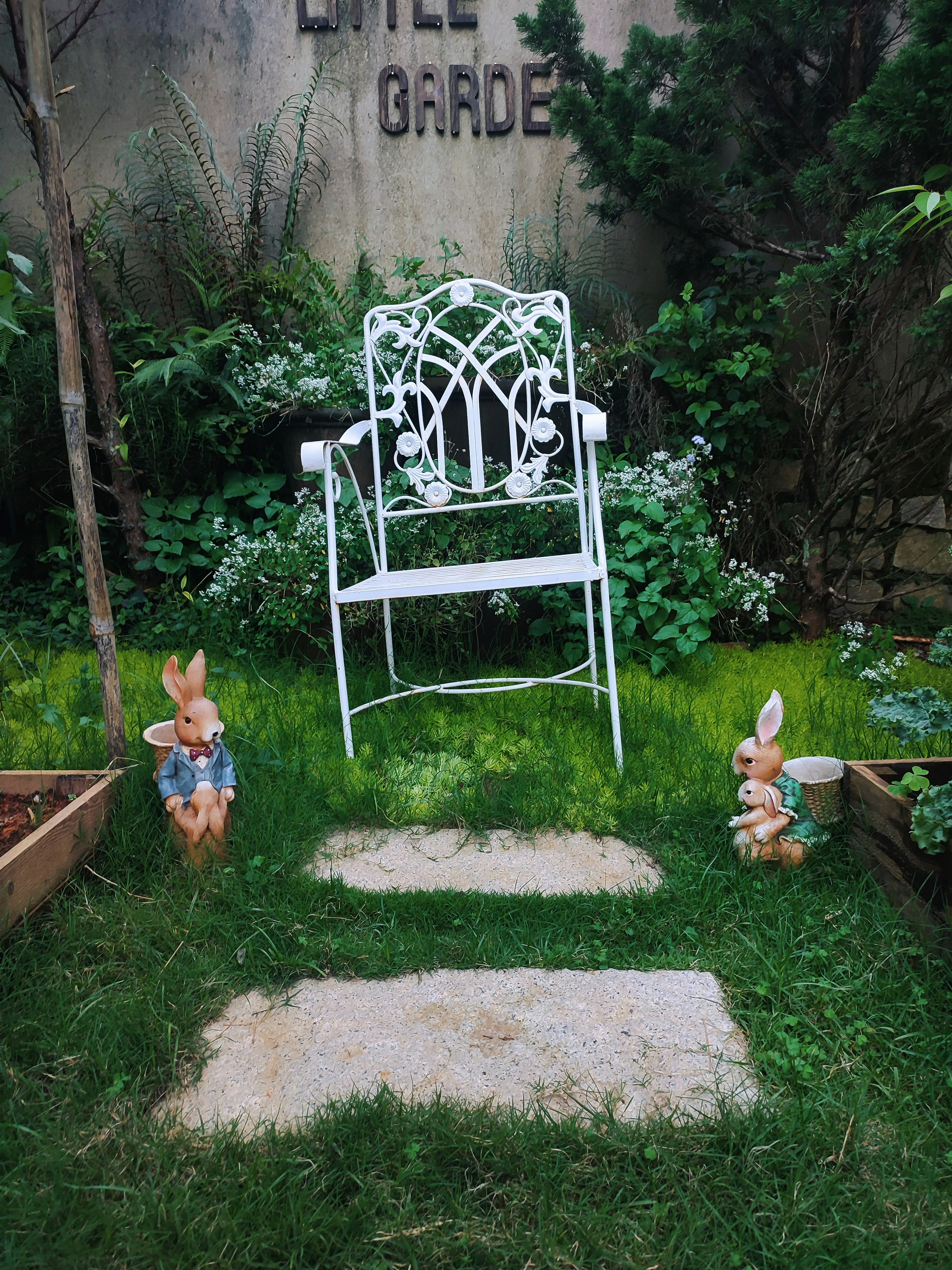 A garden with a white bench and two little rabbits photo – Free Nature ...