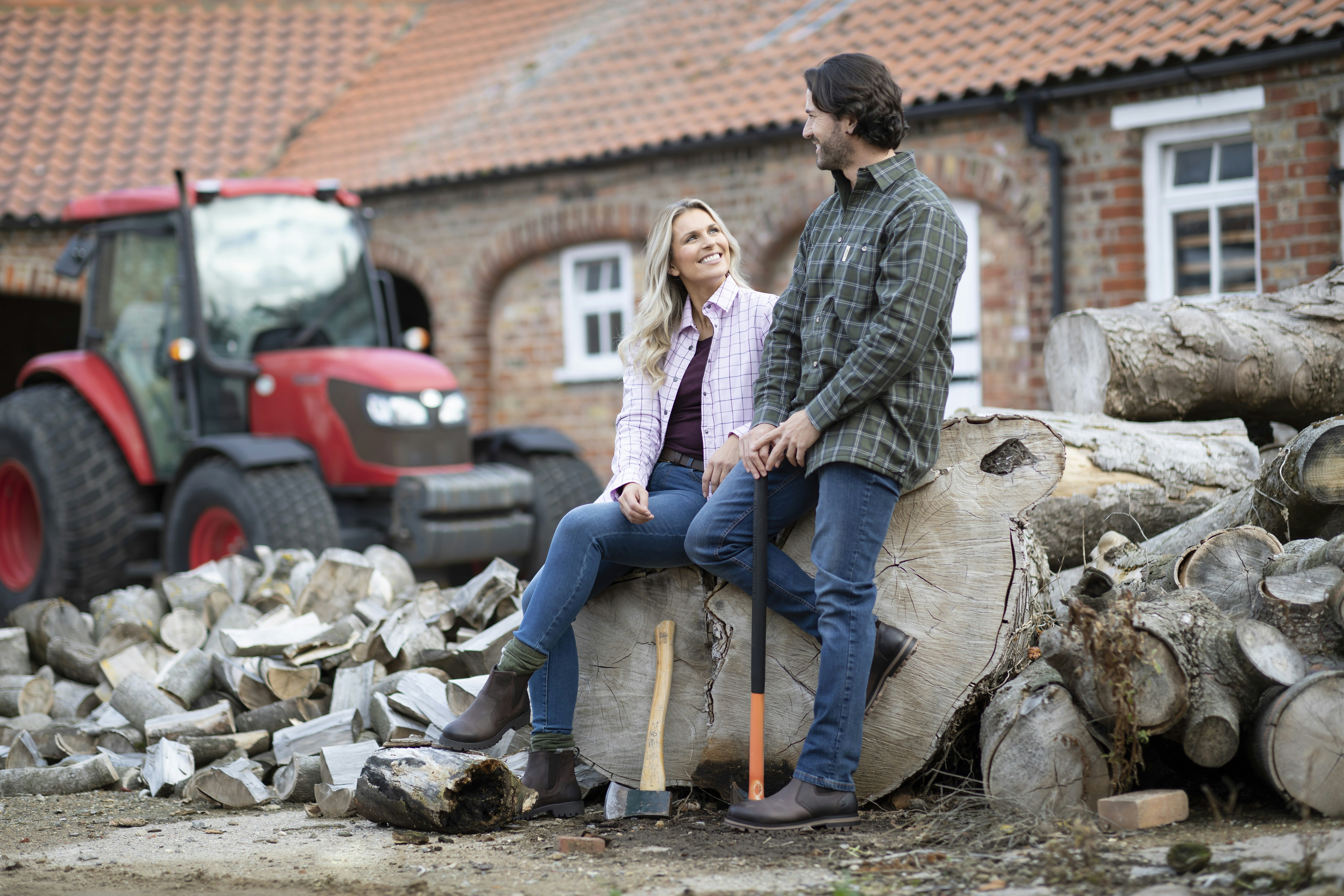 Pause by the Woodpile: A Couple's Quiet Moment in a Rural Yard