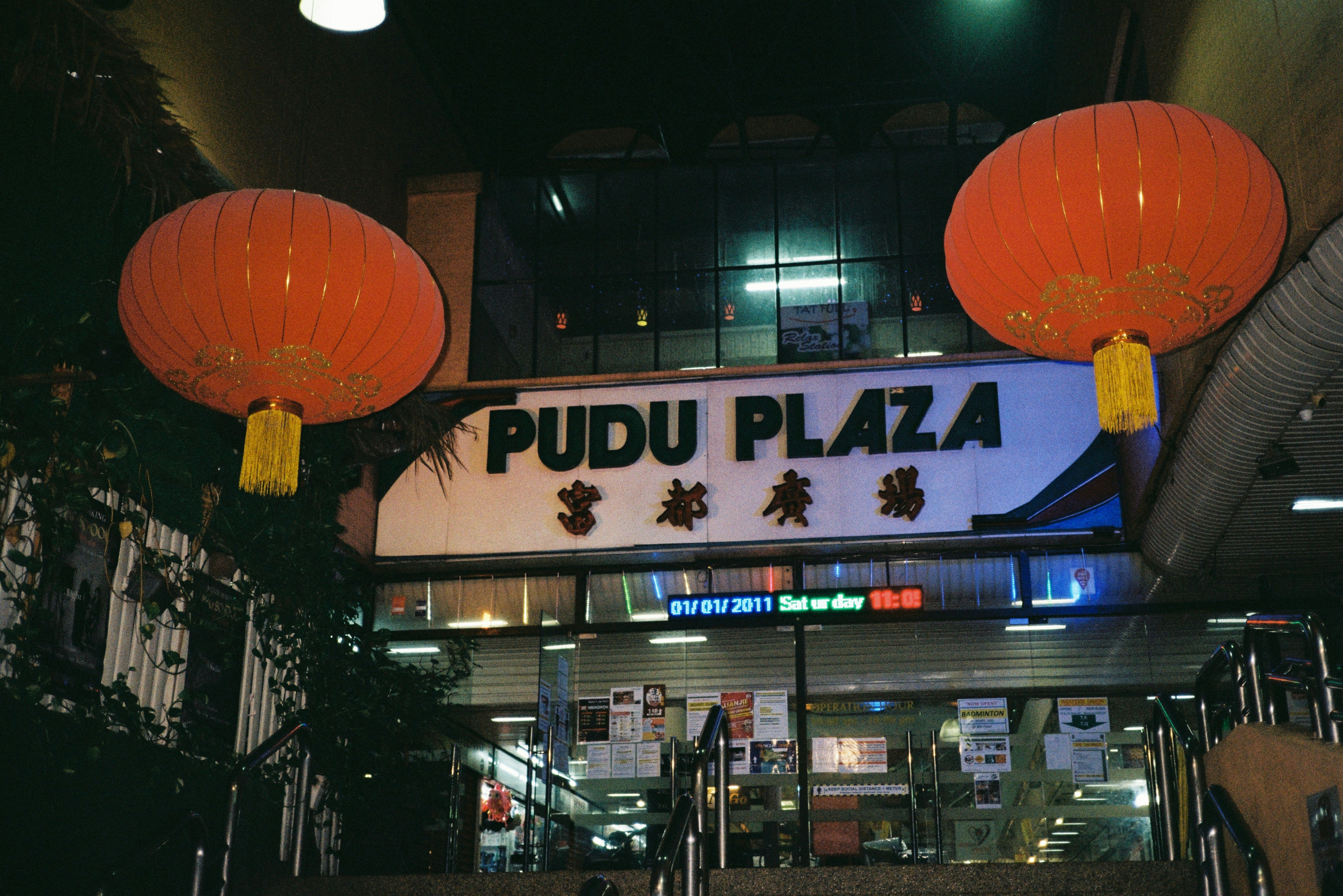 A building with a sign that says pudu plaza photo – Free Film Image on ...