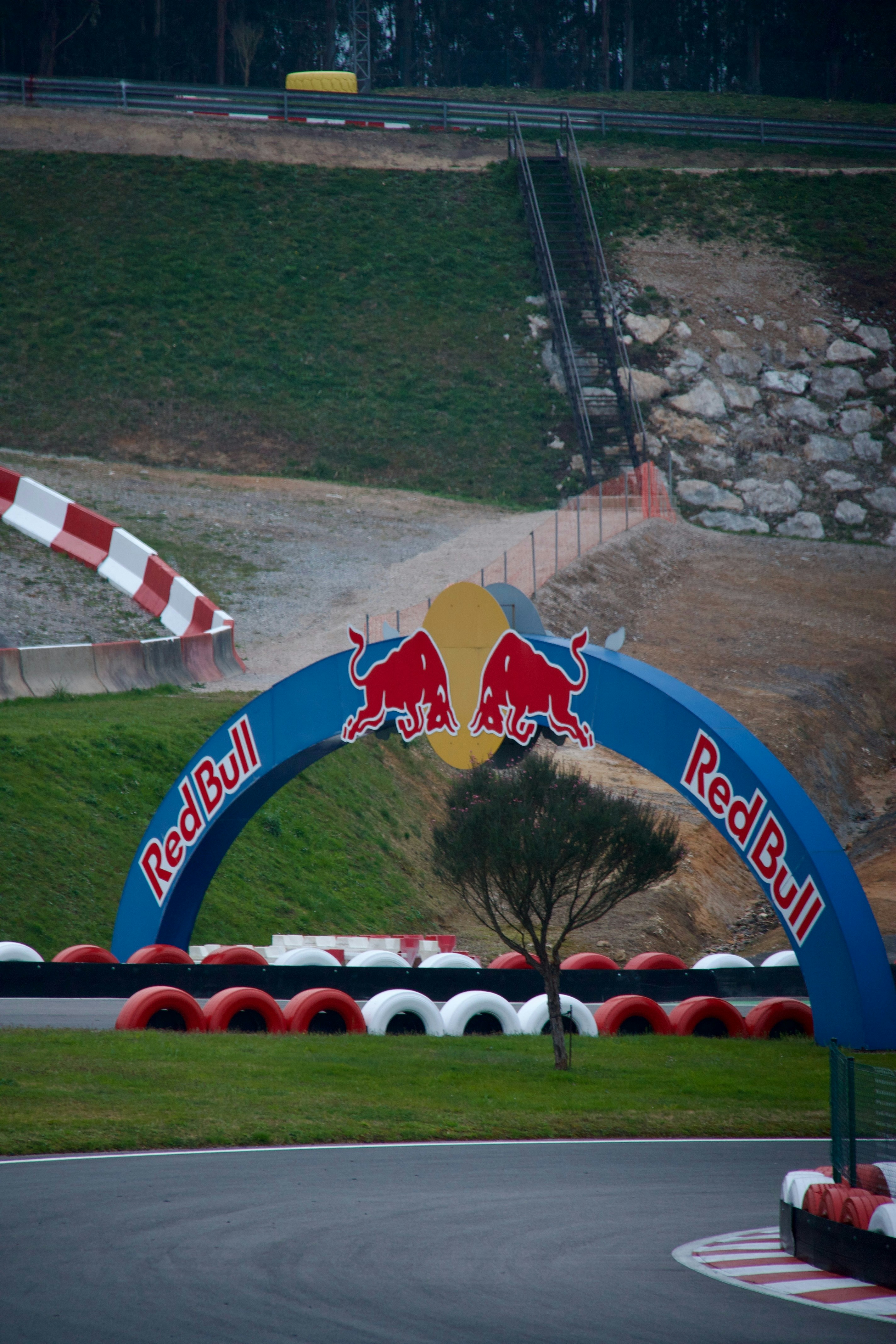 A red bull sign on a race track photo – Free Road Image on Unsplash