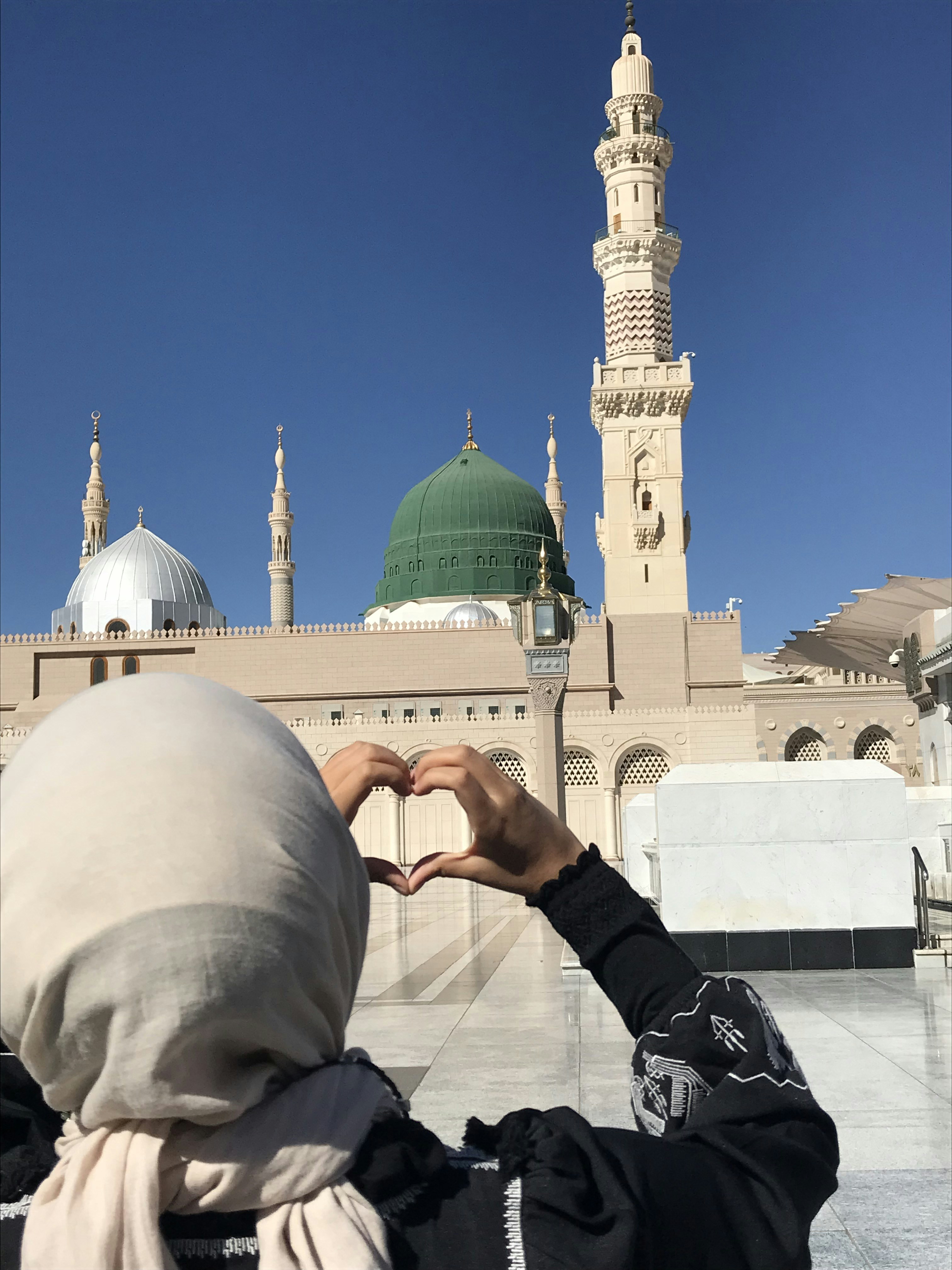 a woman making a heart shape with her hands