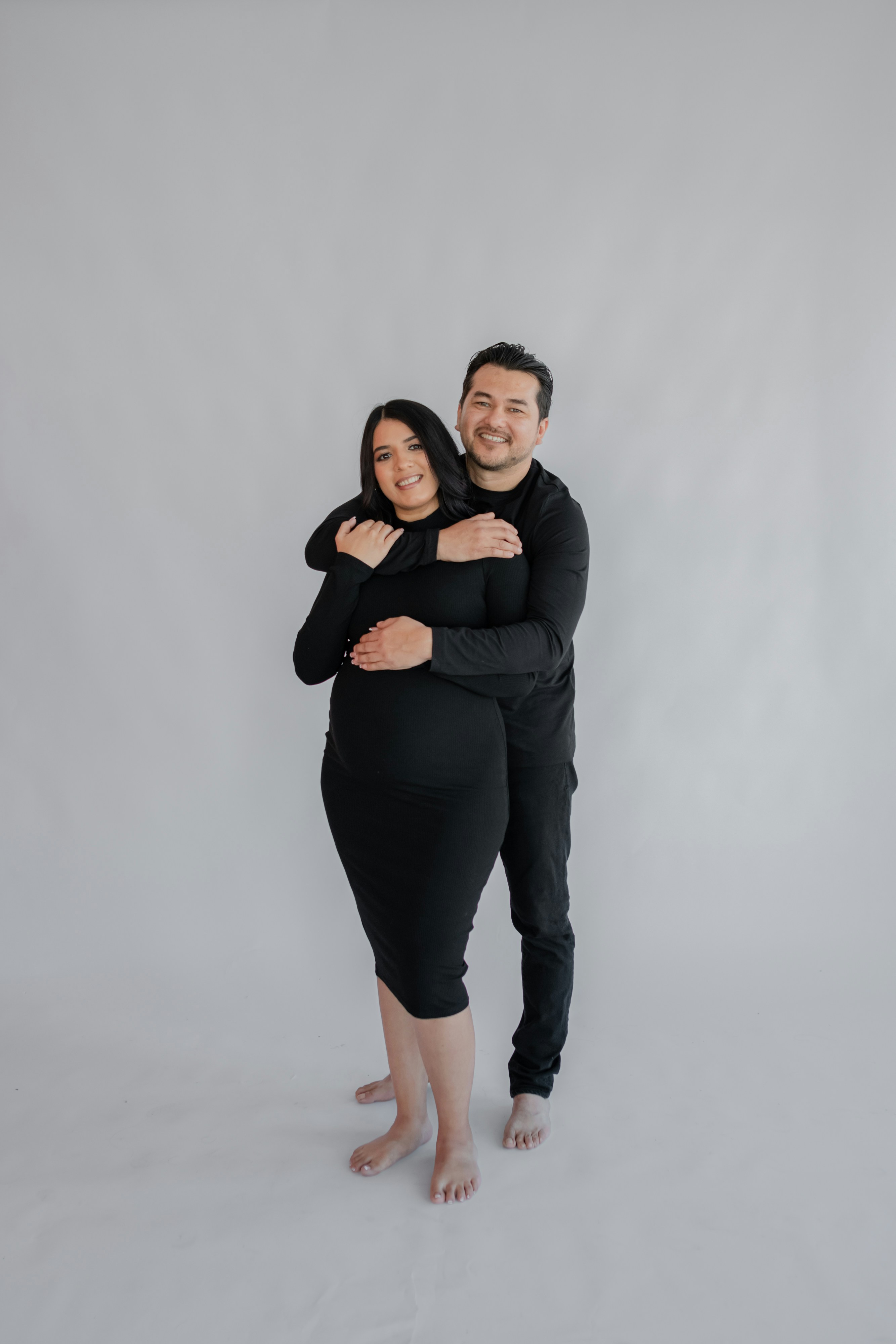 a man and a woman standing together in a studio