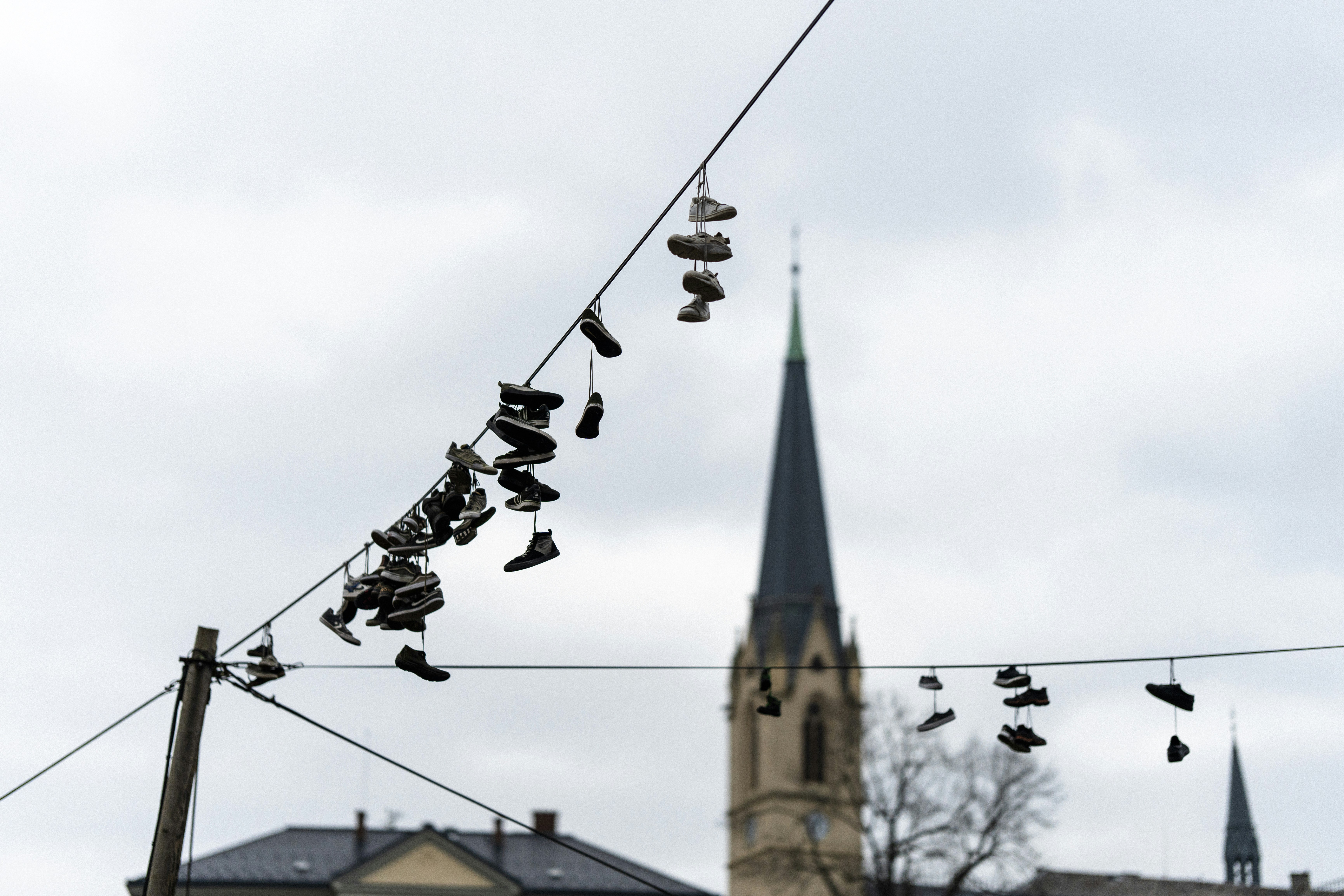Shoes on a Wire: Quiet Urban Choir Under a Gothic Spire