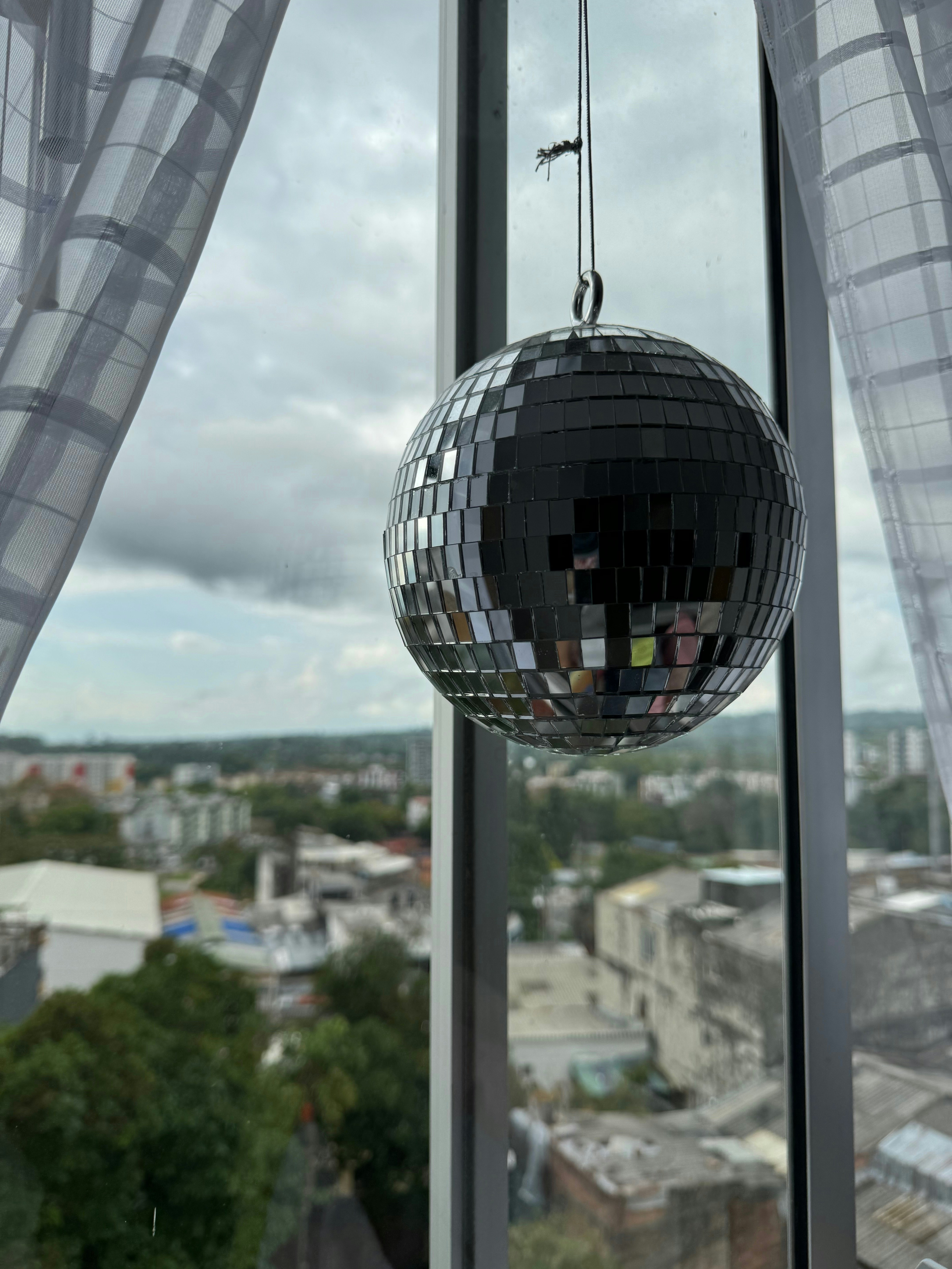 A disco ball hanging from the side of a window photo – Free Quindío ...