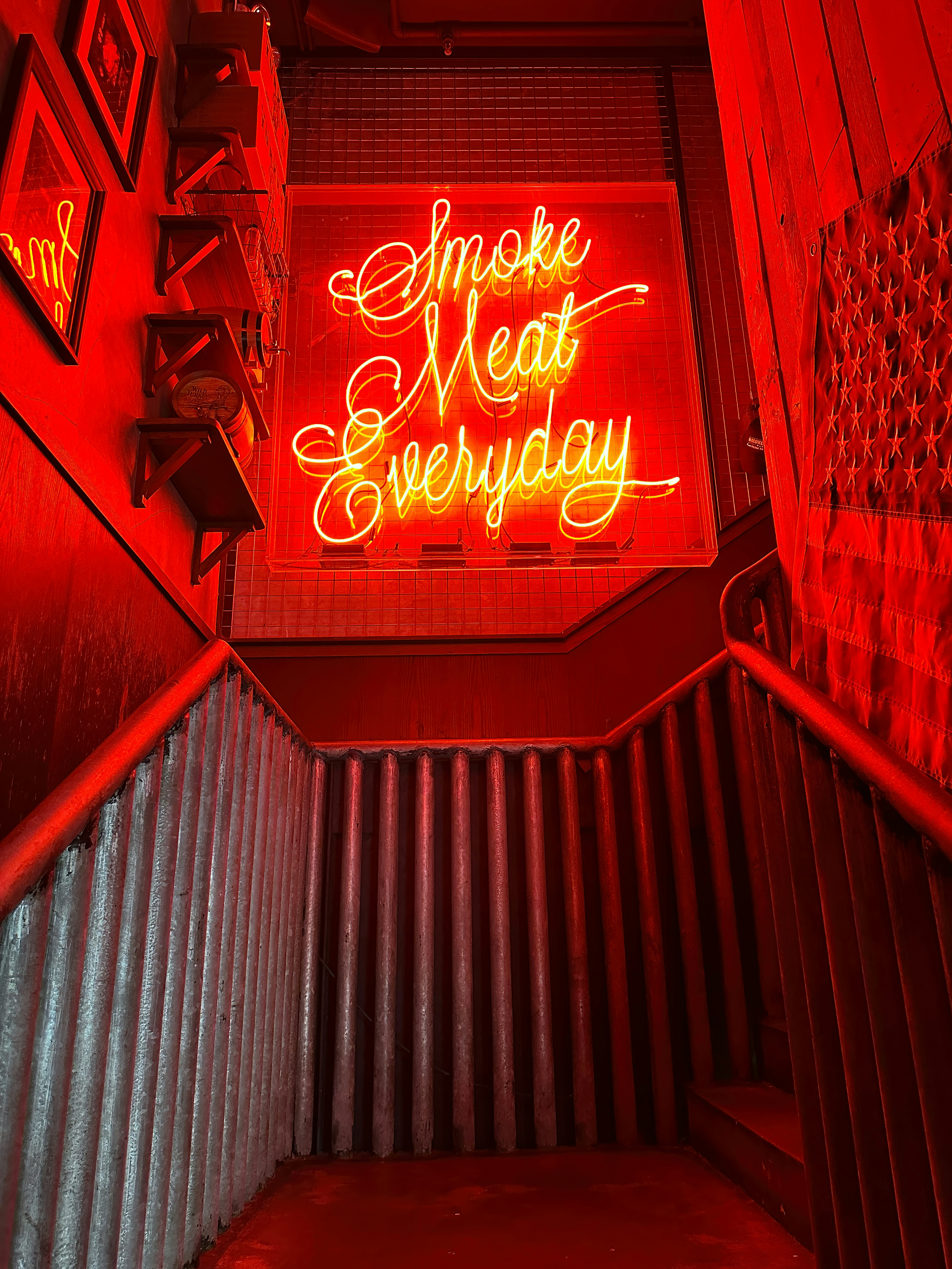 Neon Stairs Under a Red Glow: Smoke, Meat, Everyday