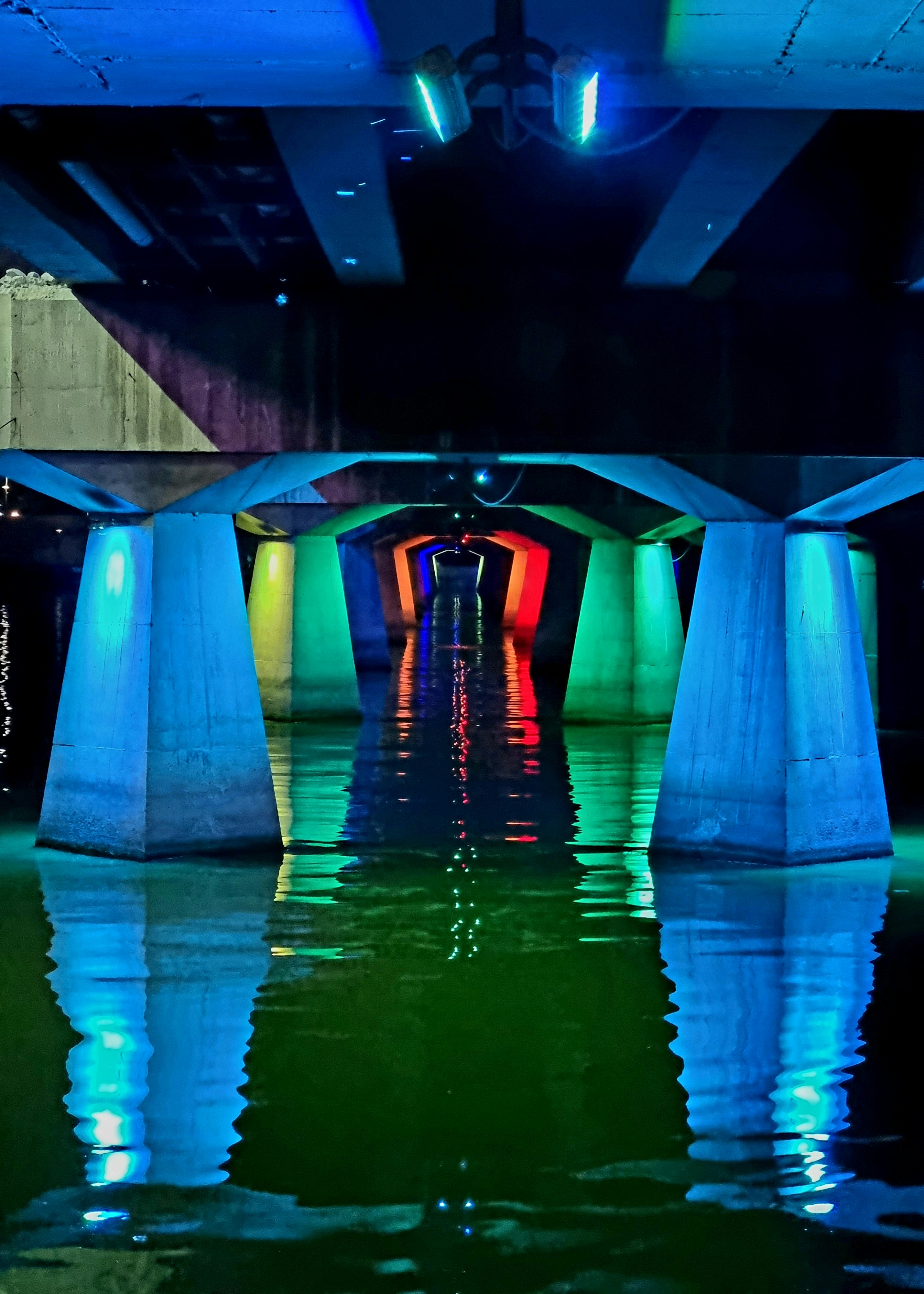 Neon Rainbow Corridor Beneath the Bridge