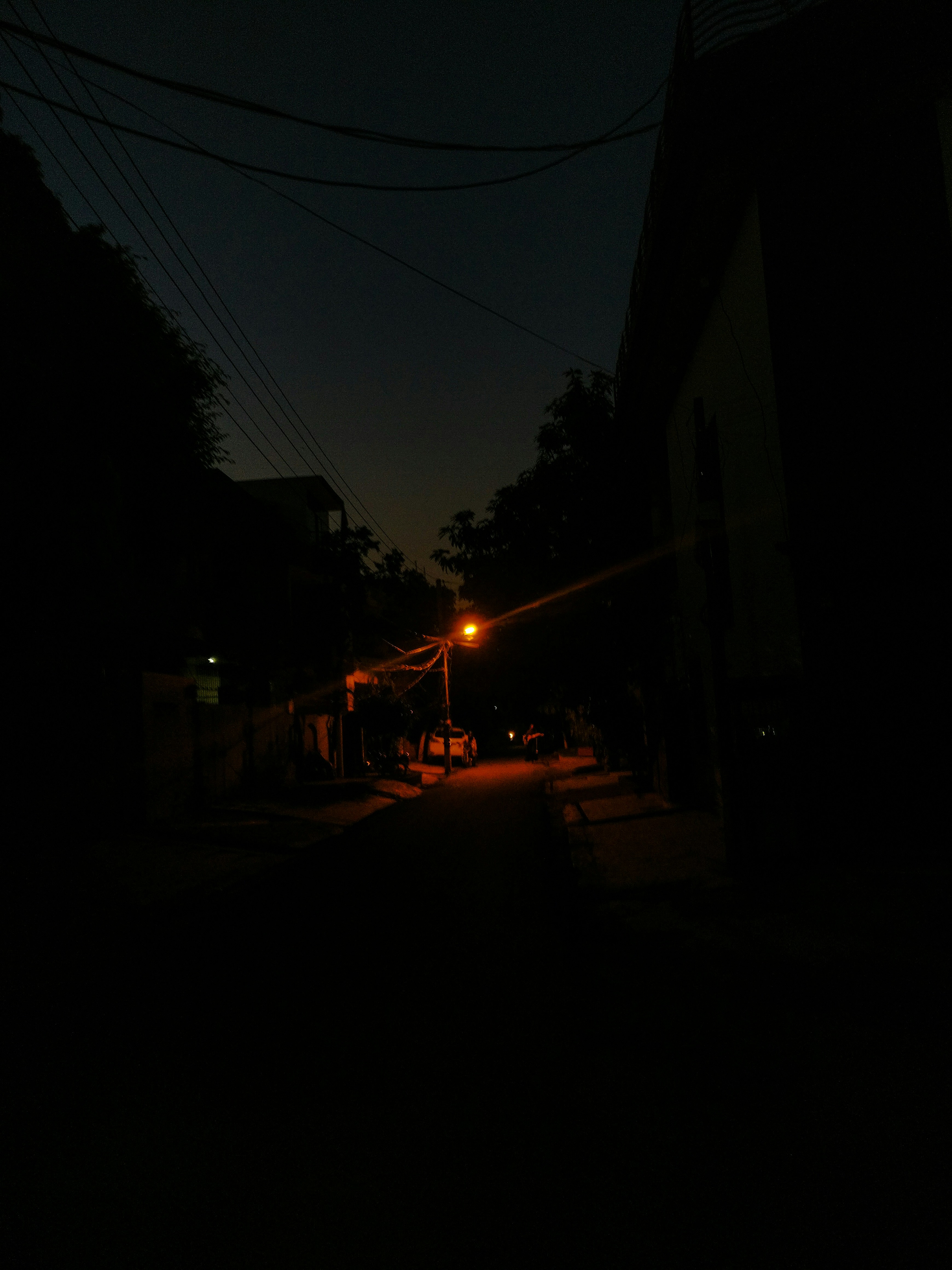 A dark street at night with a street light photo – Free Street Image on ...