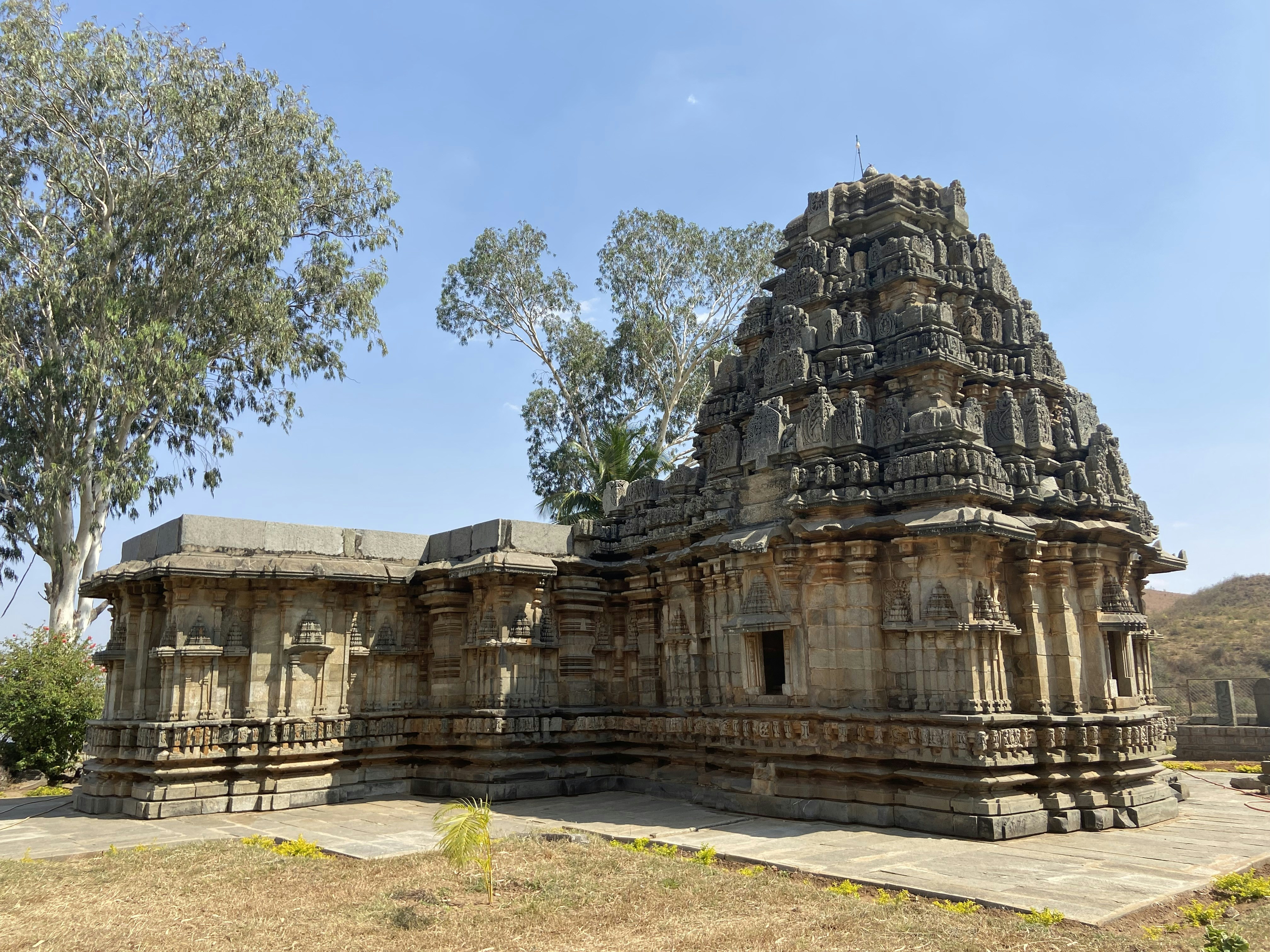 A large stone structure with a tree in the background photo – Free ...