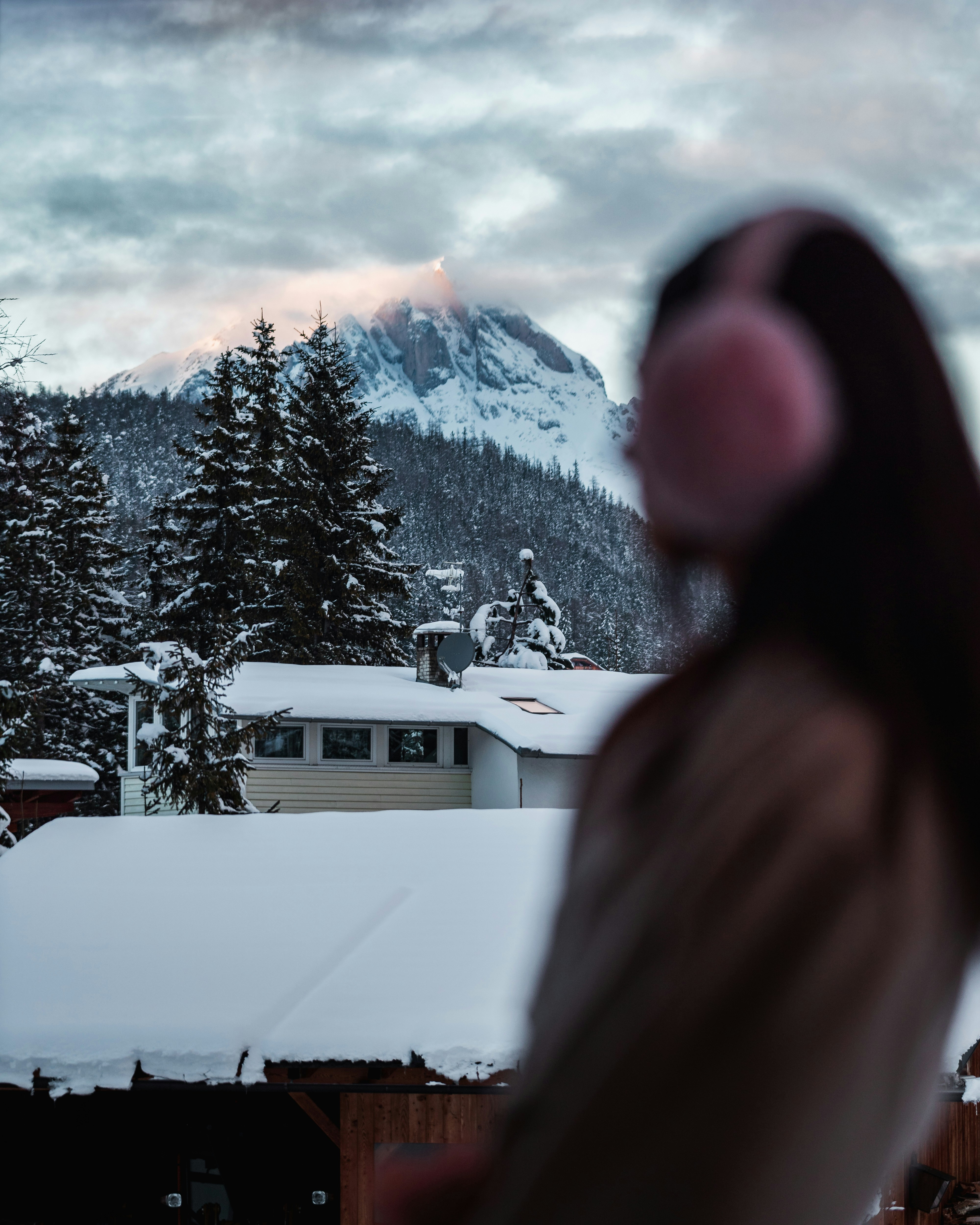 Snowy village over the shoulder gaze toward distant peaks
