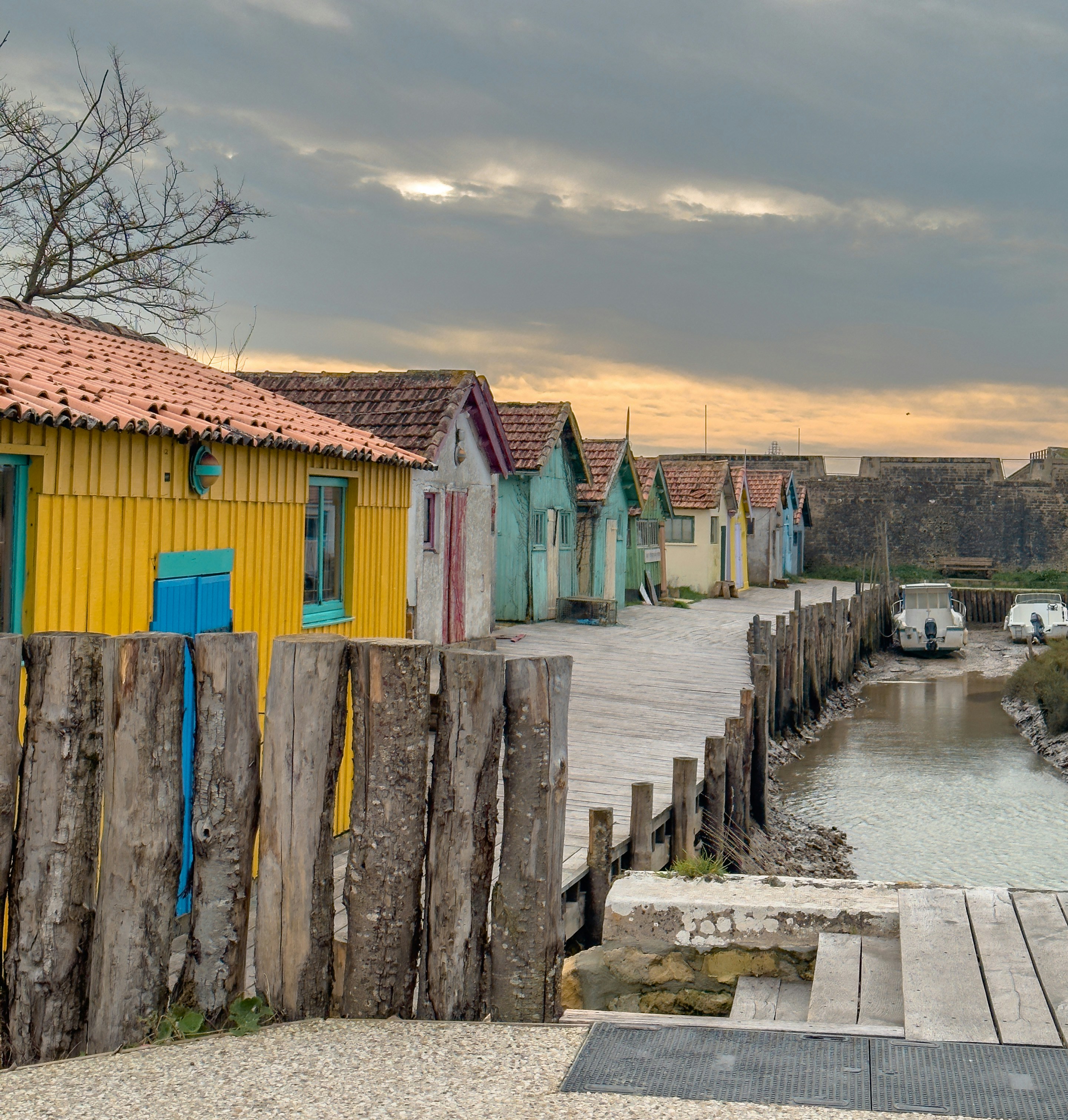 Rainbow Boathouses along a Sunset Canal