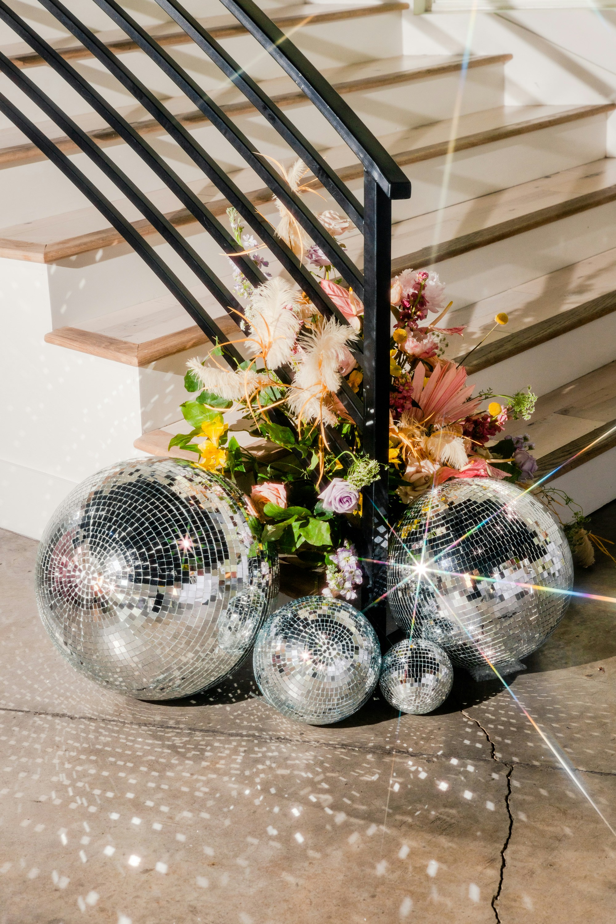 Disco Spheres Beside a Staircase: Floral Burst and Mirror Glow