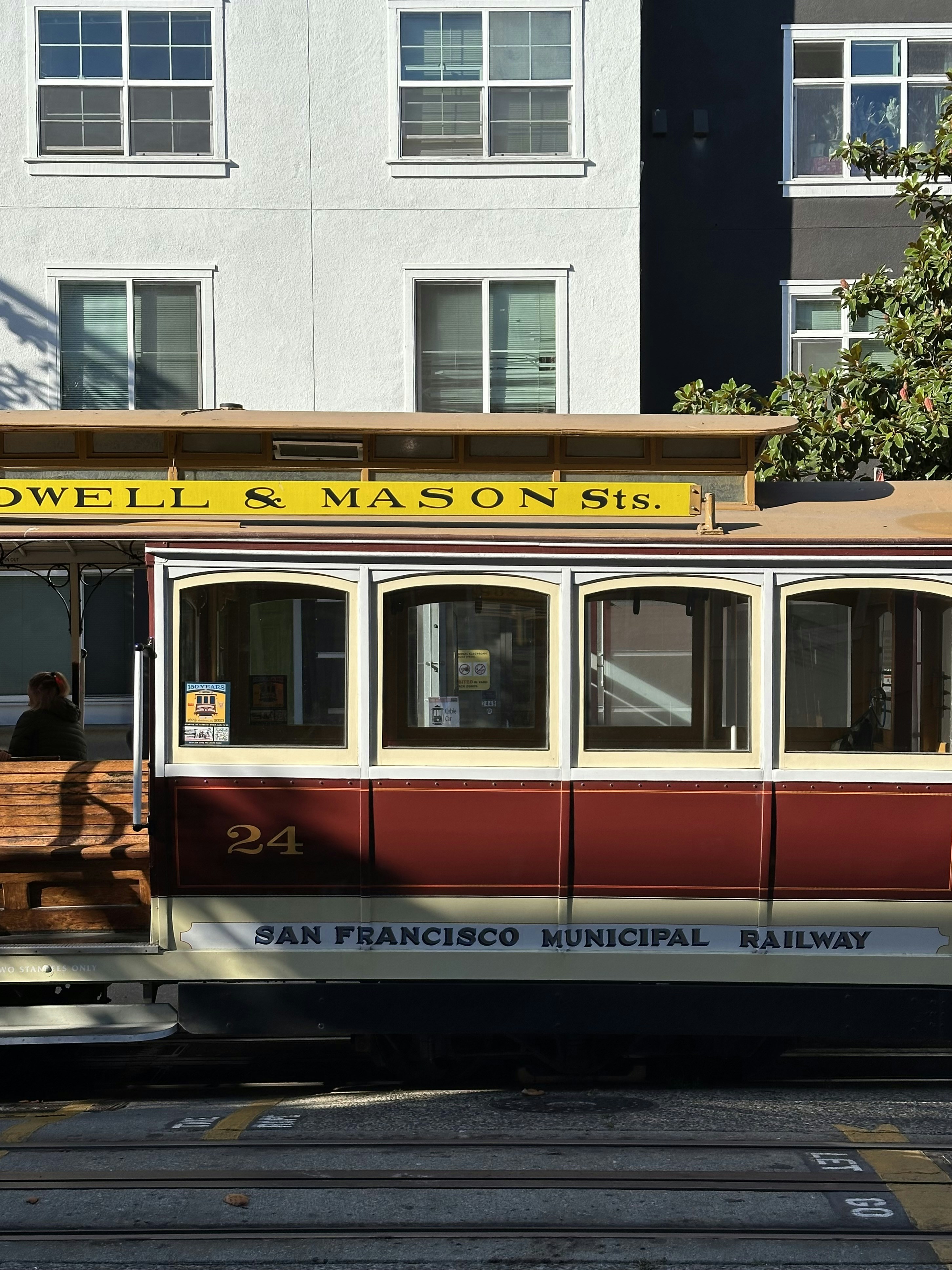 Streetcar at Studio Row: A Vintage Ride Over Tracks