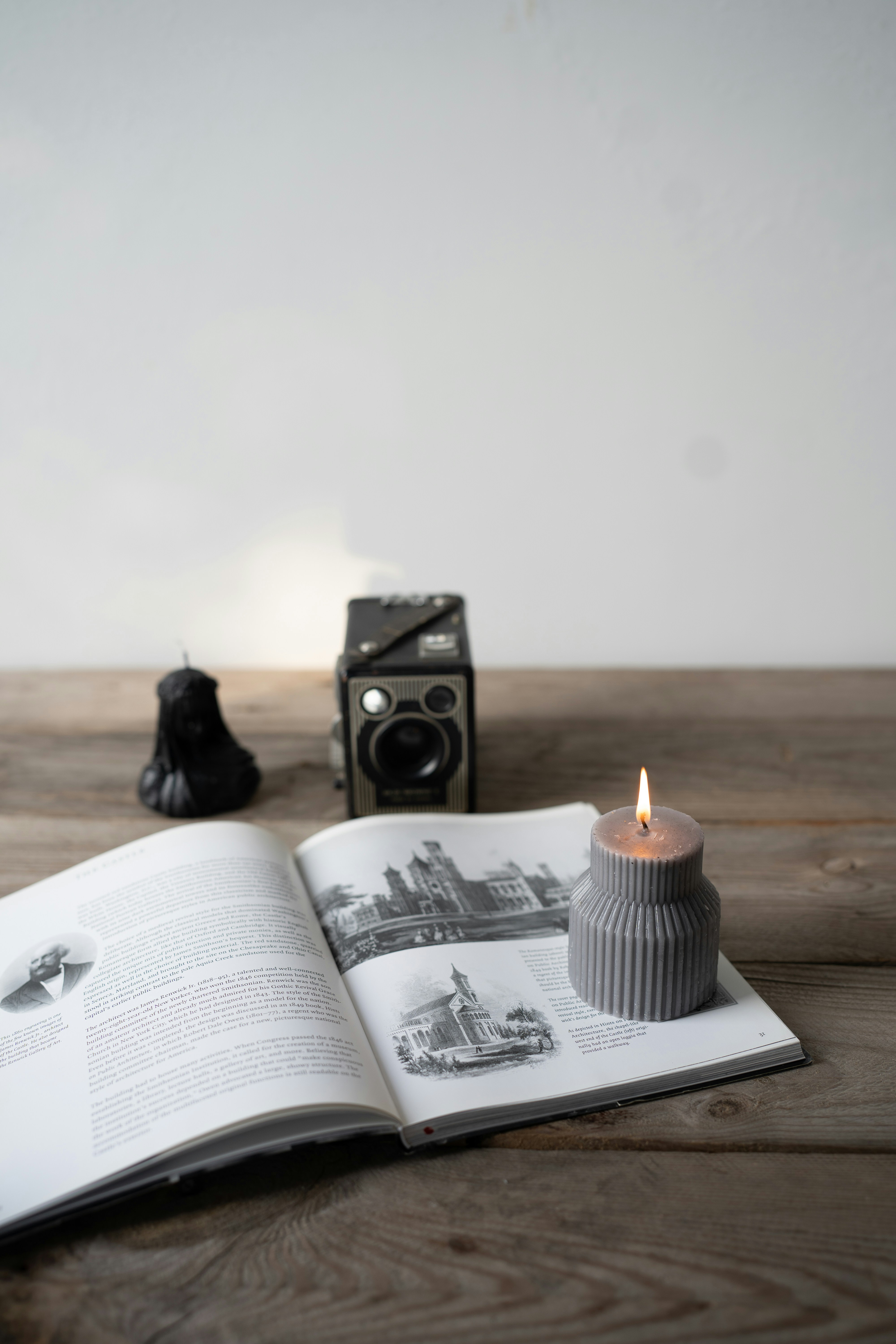 A Quiet Page, a Warm Flame: Still Life Evening with Vintage Camera