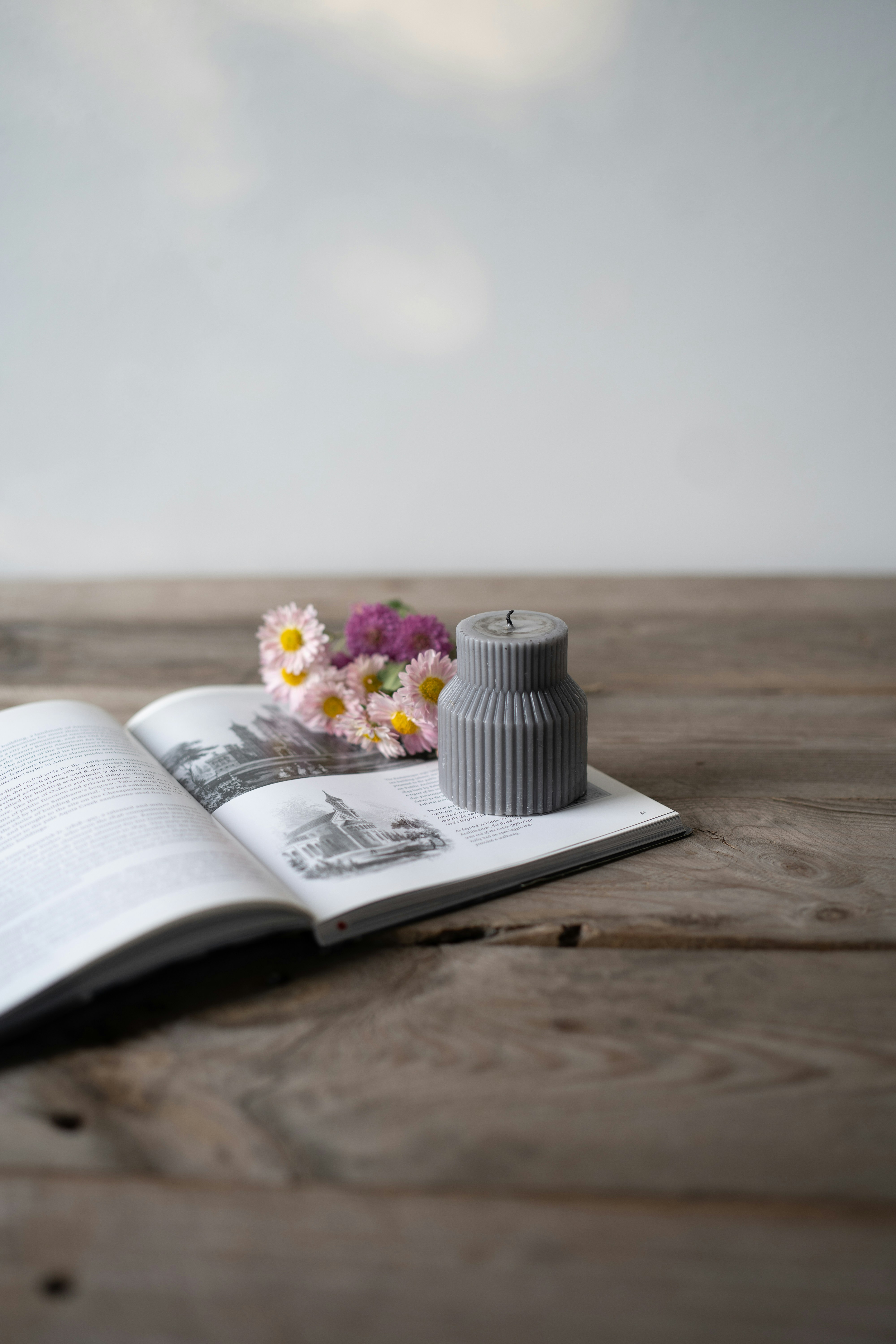 a book with a vase of flowers on top of it