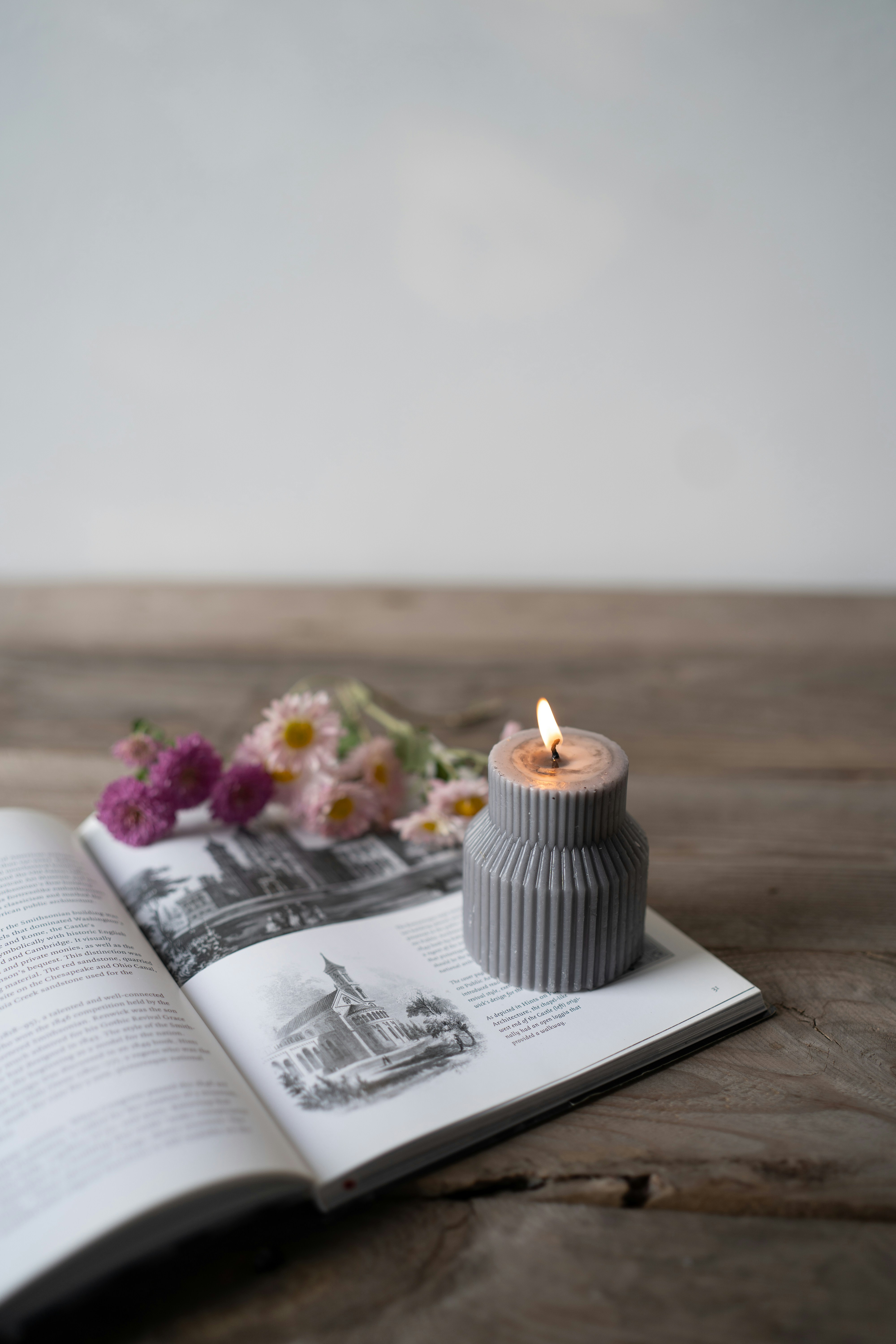 Flame, Page, and Petals: Quiet Ritual on a Wooden Table