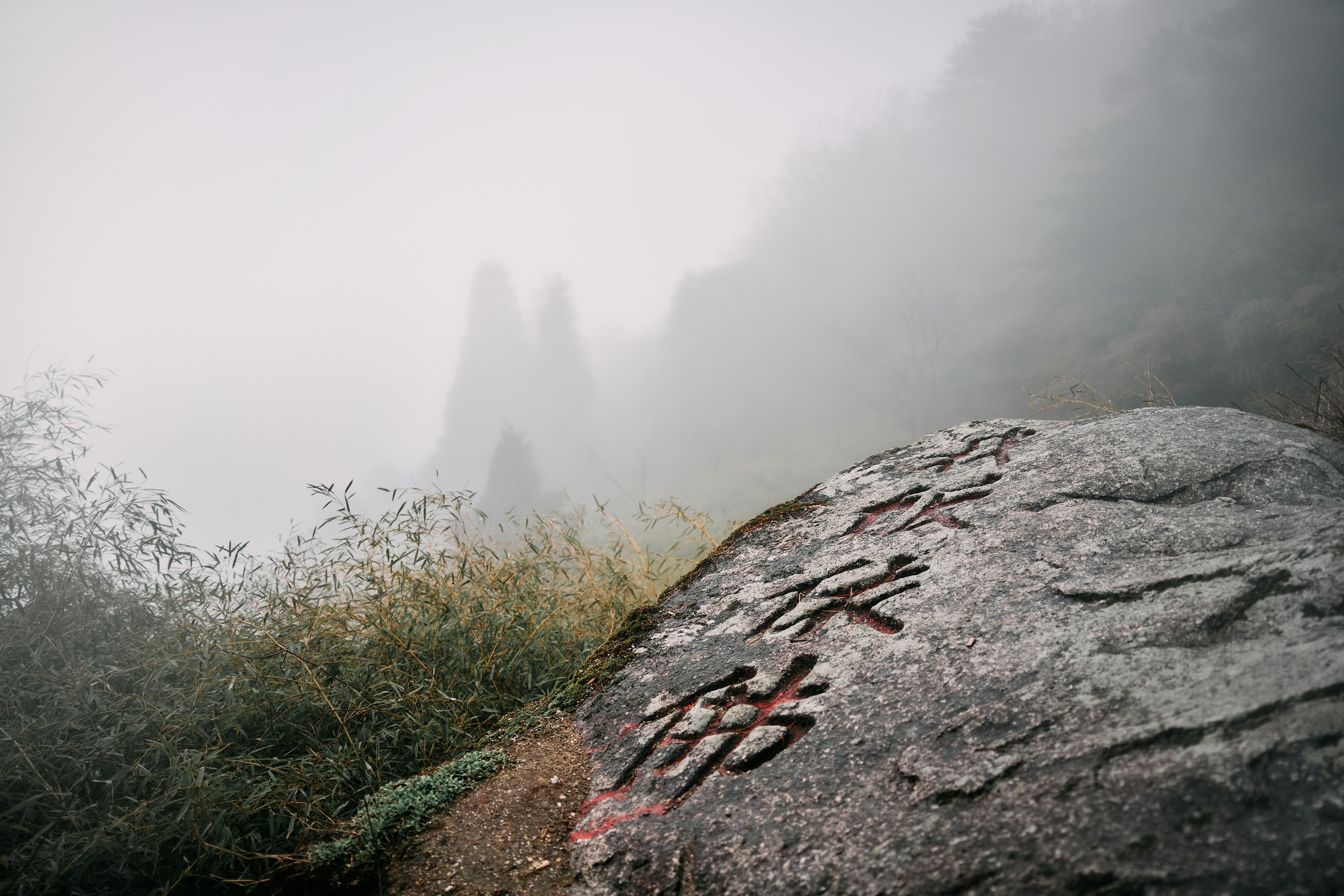 Red Script on Mist-Kissed Granite