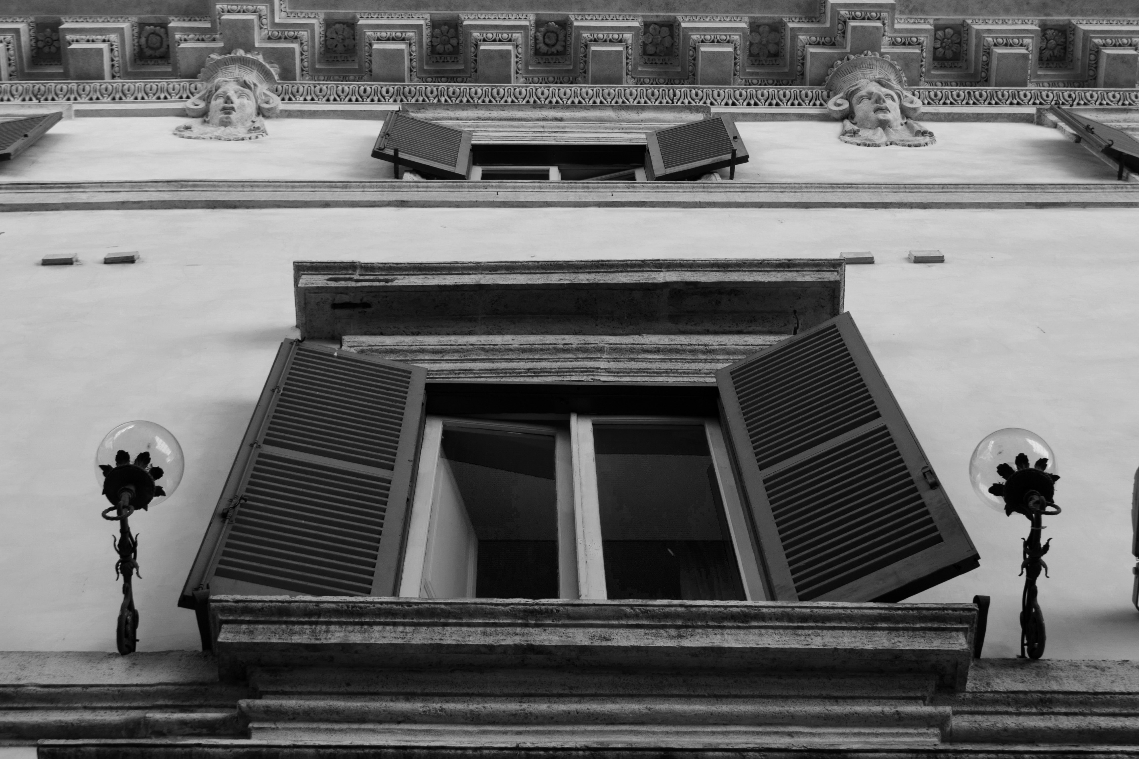 Central Window in Monochrome: A Historic Facade's Quiet Symmetry