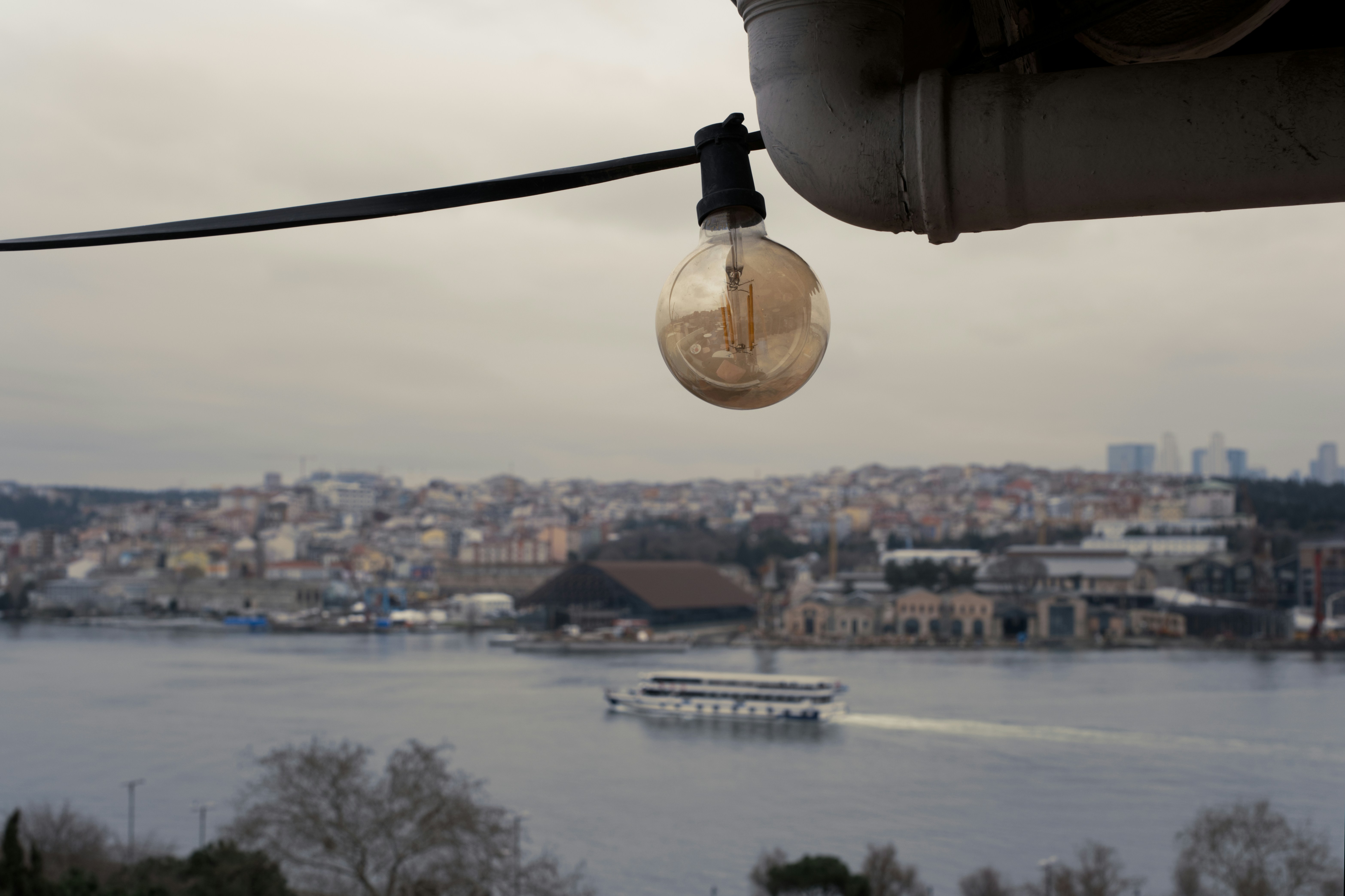 Bulb in Focus, Distant Harbor: A Quiet Cityscape
