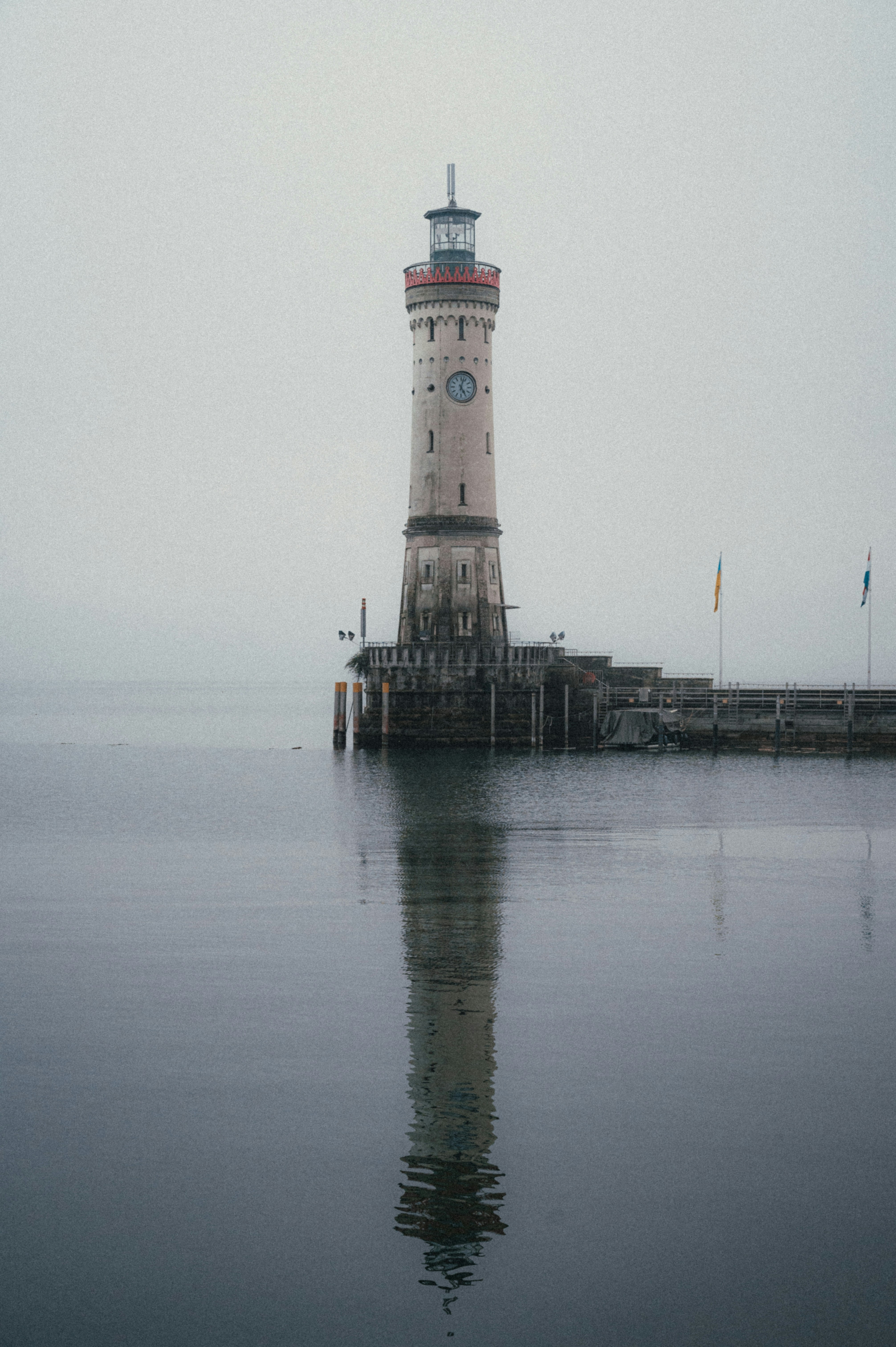 Mistbound Beacon: A solitary lighthouse guarding a glassy harbor.