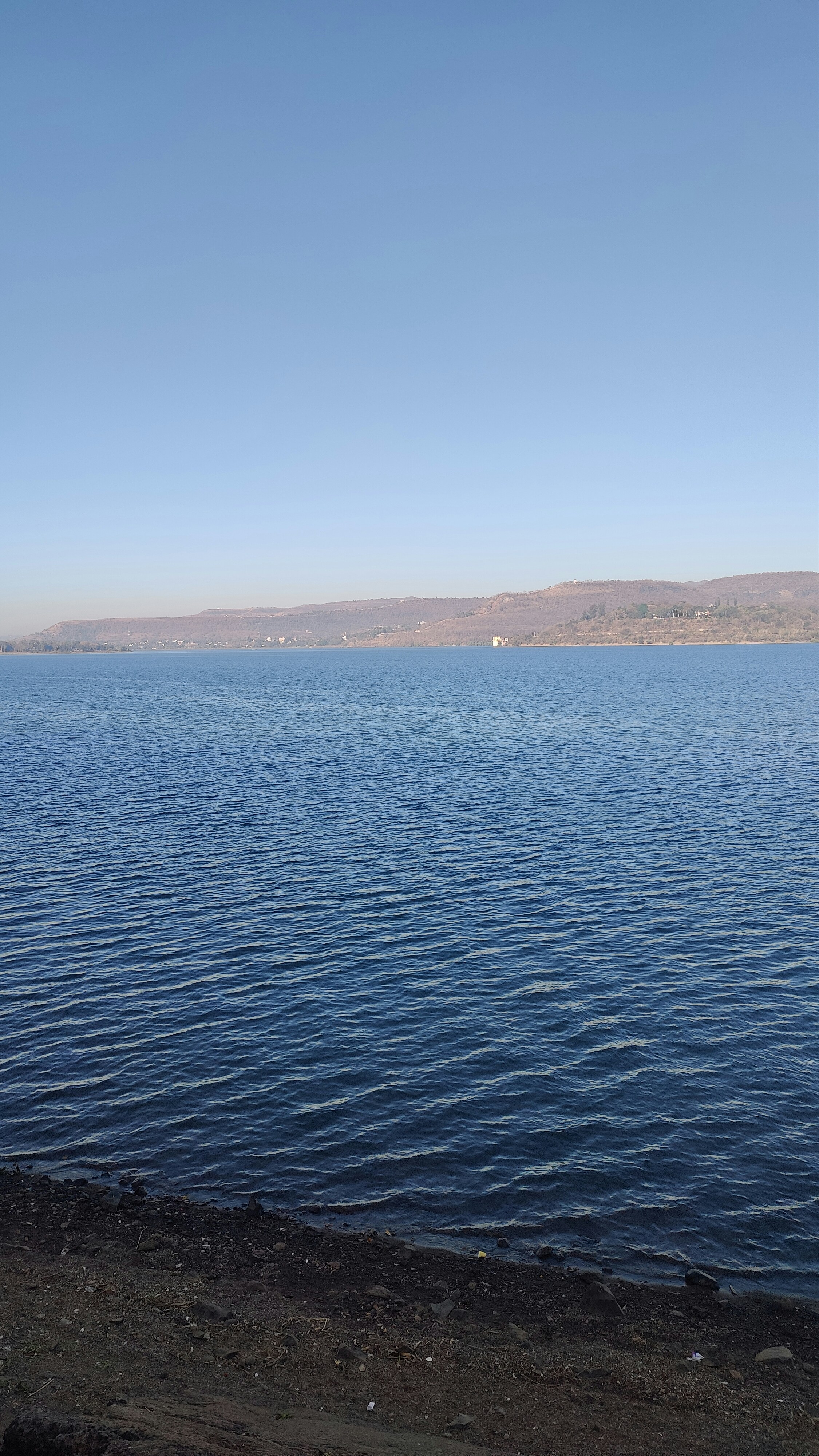 Horizon Line over Quiet Blue: Coastal Calm at Distant Ridge