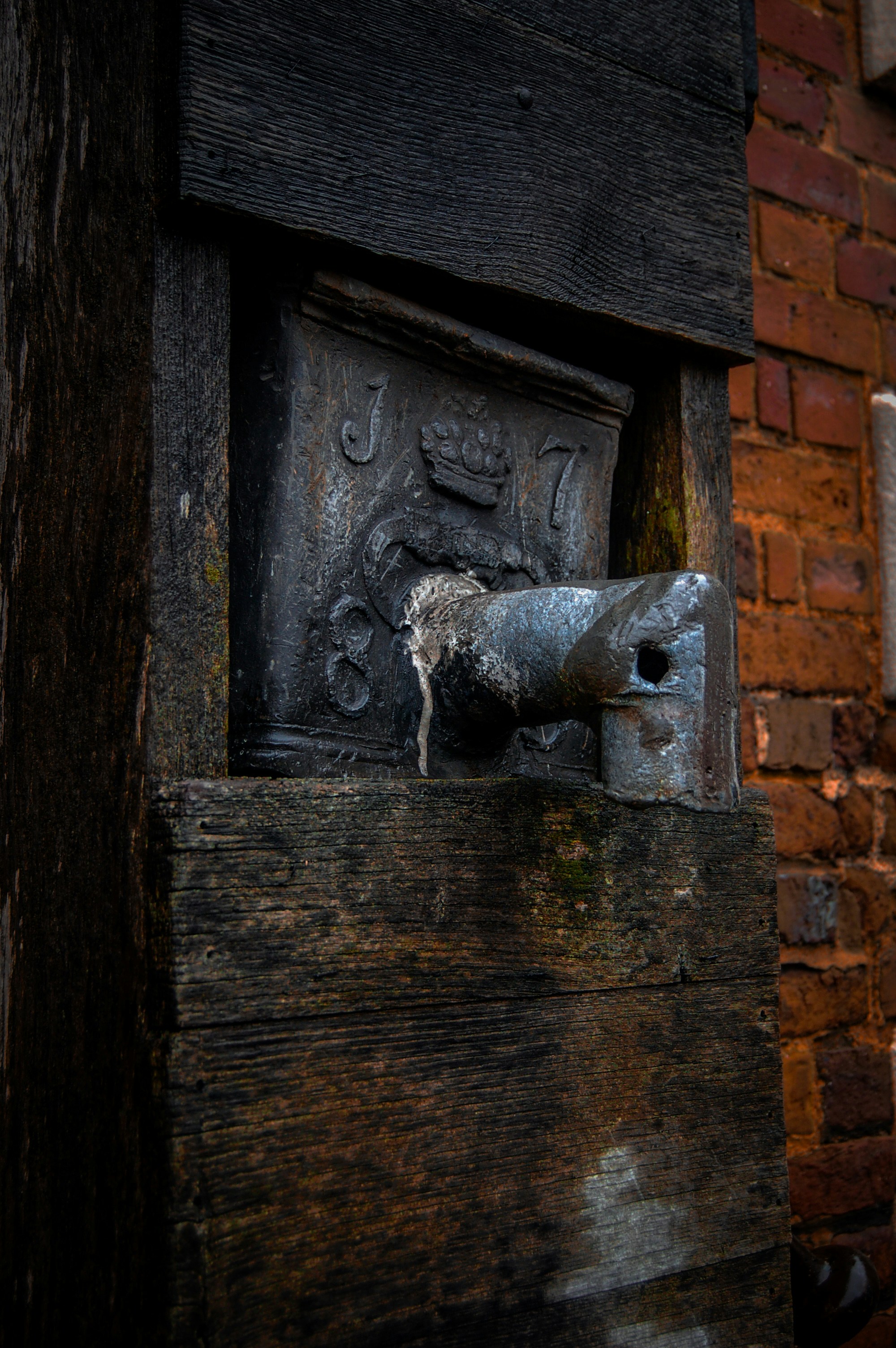 Weathered Block and Iron Spout: Echoes of a Doorway