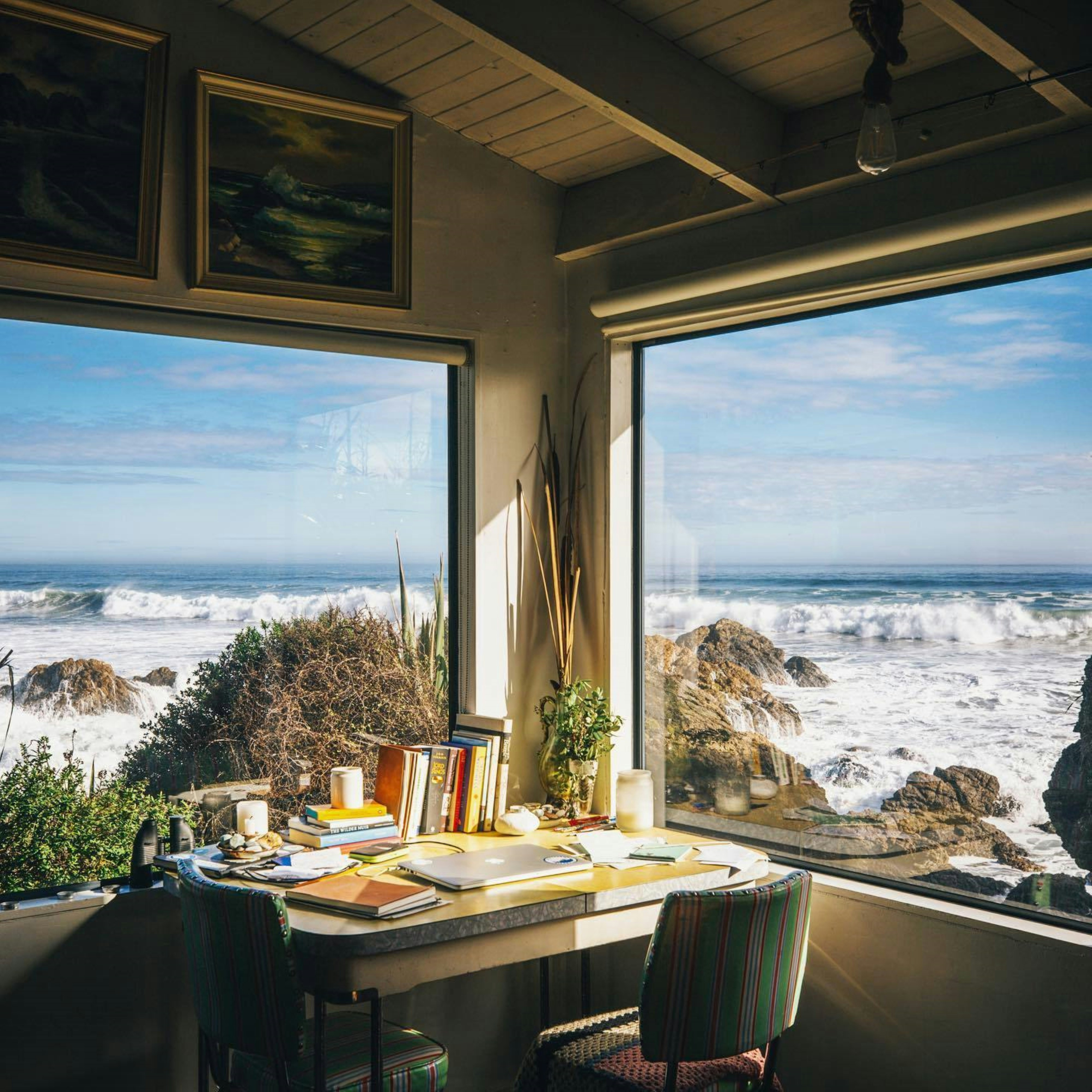 A desk in front of a window with a view of the ocean photo – Free ...