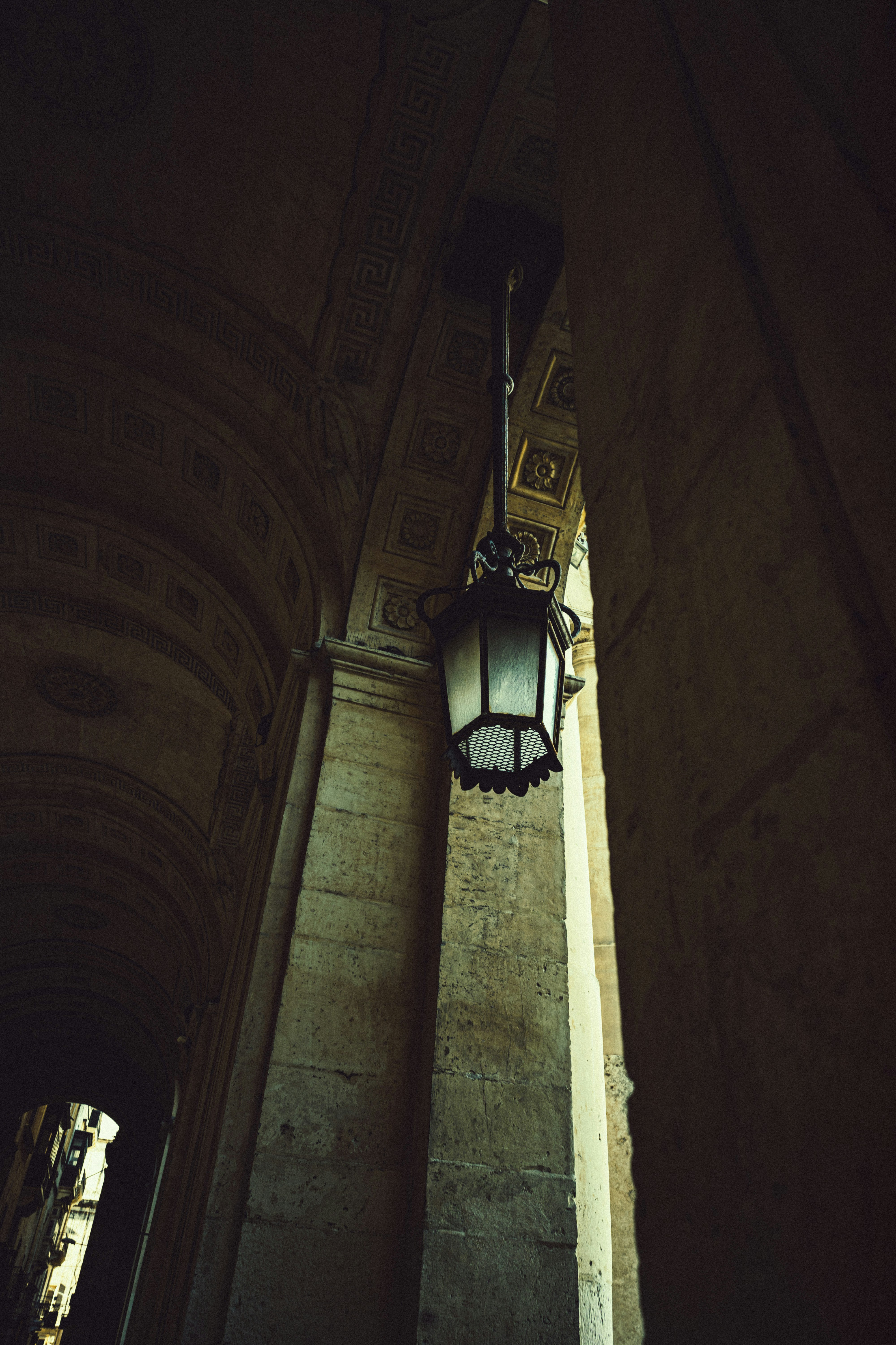 Iron Lantern in a Shadowed Arcade Corridor