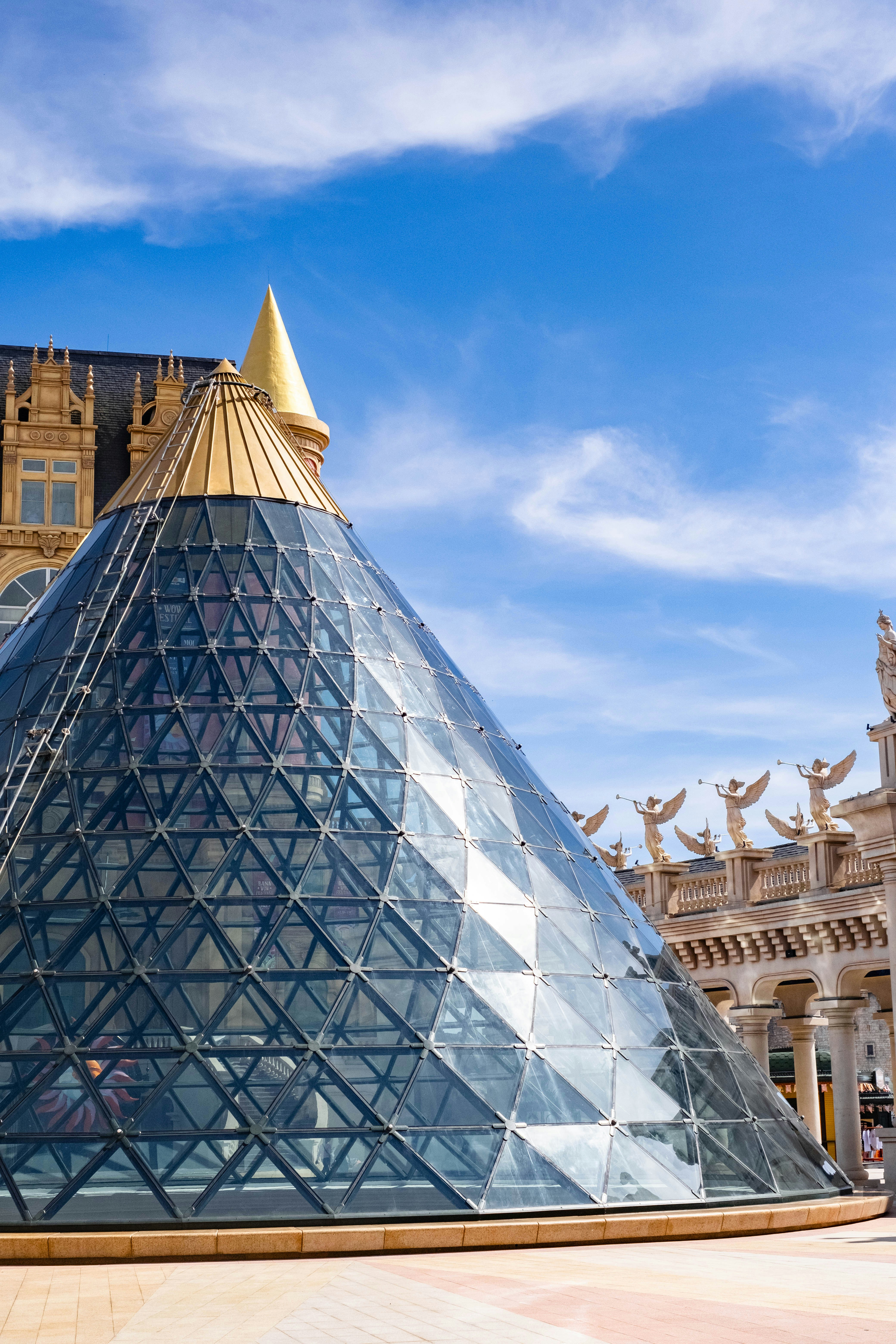 A large glass pyramid in front of a building photo – Free Building ...