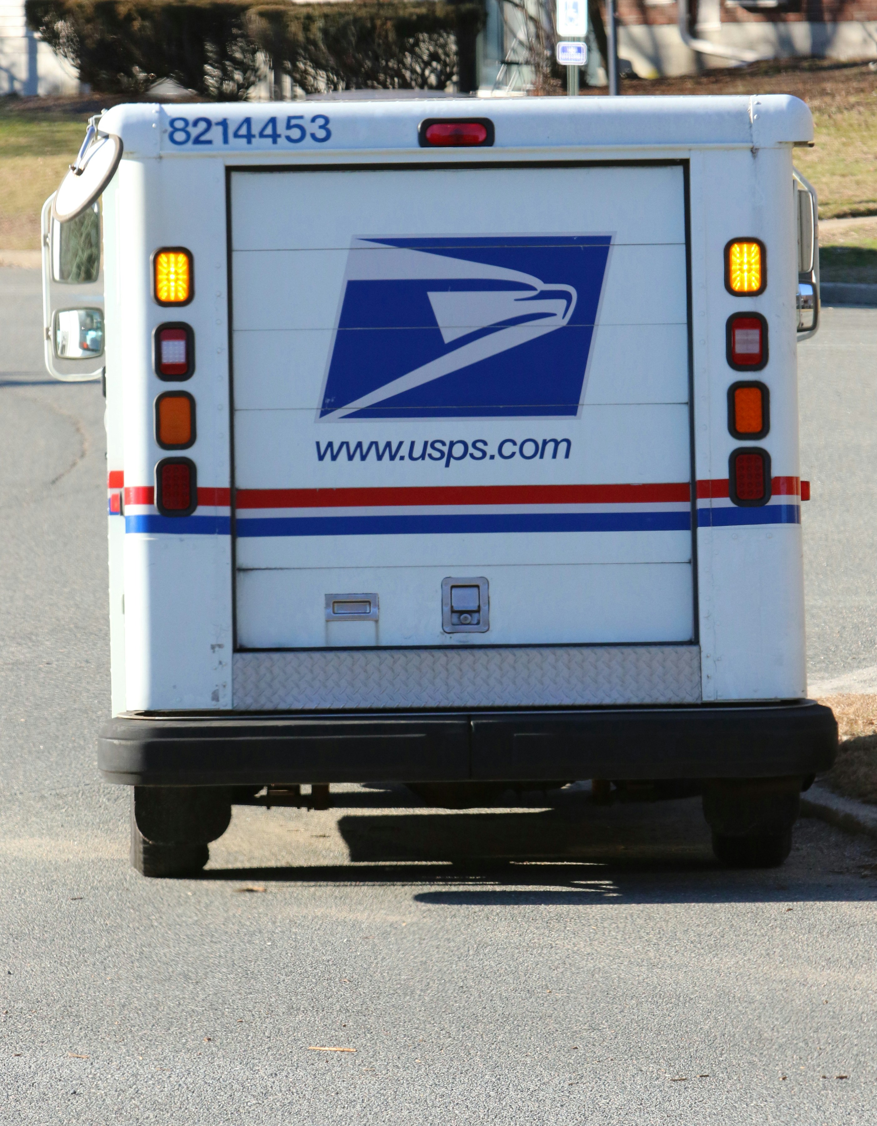 The back of a mail truck on a city street photo – Free Milford Image on ...