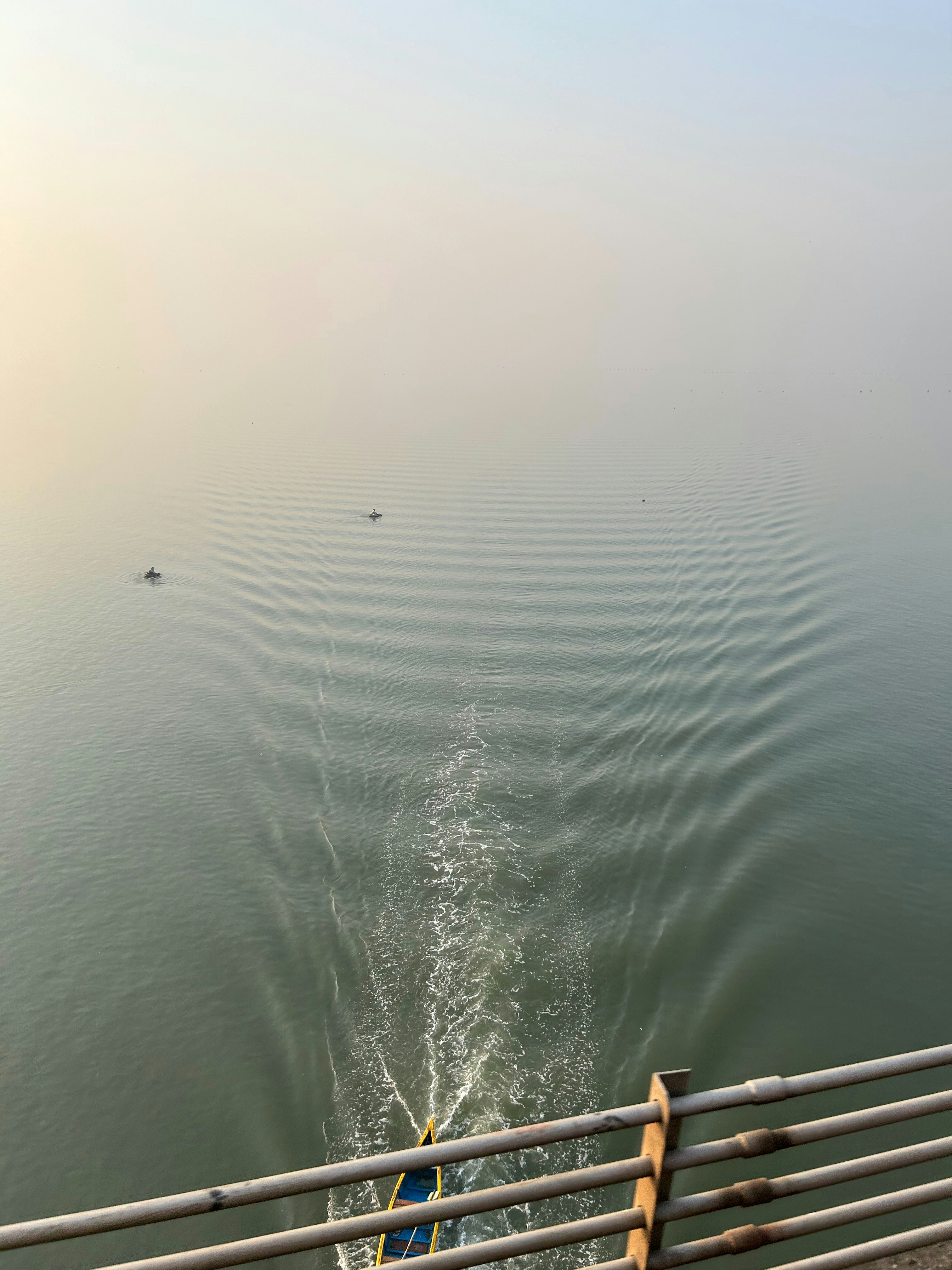 Dawn Ripples: Small Boats Carving Quiet Circles Across Calm Water
