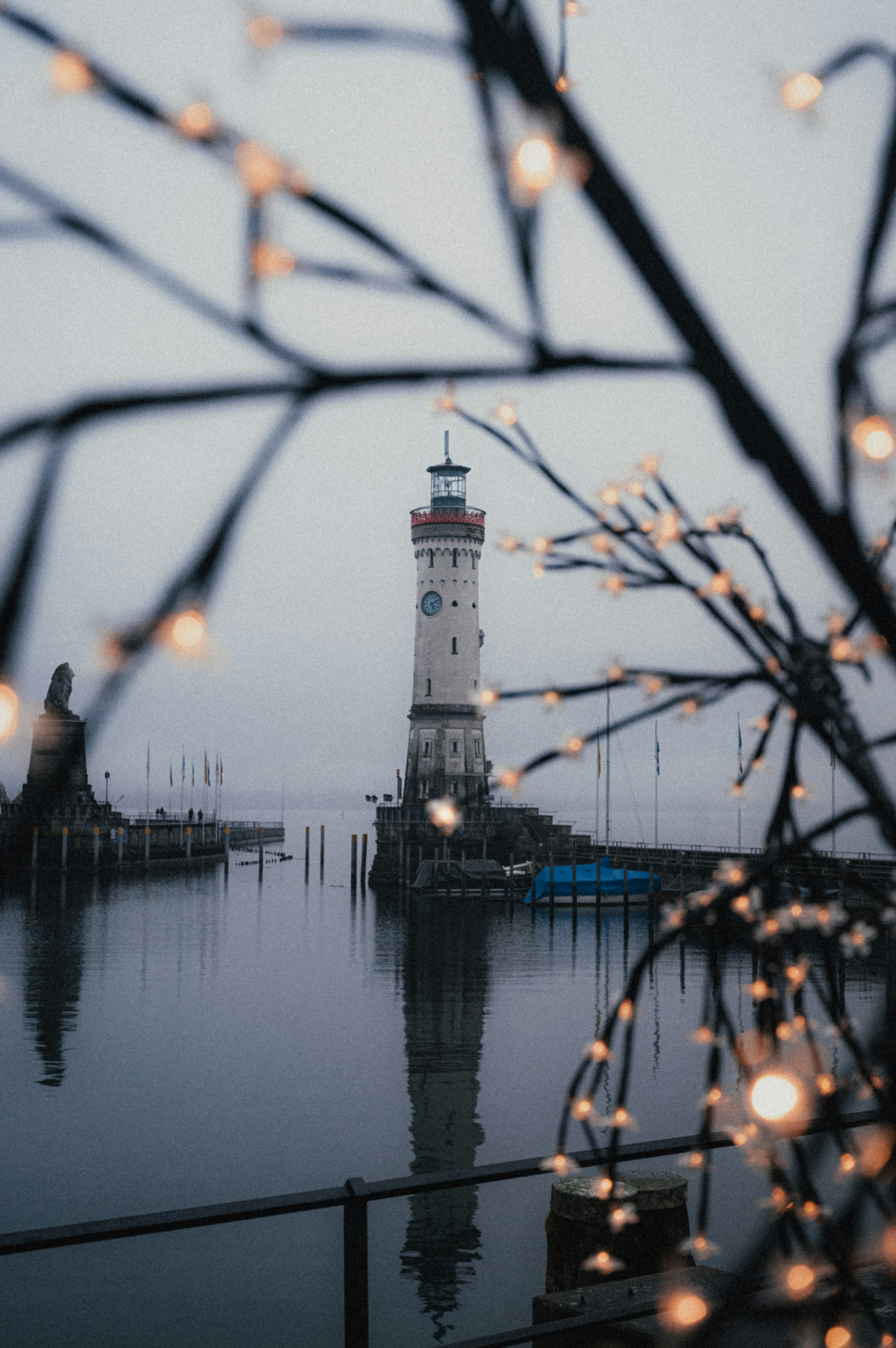 Lighthouse Framed by Twilight Bokeh on a Quiet Harbor