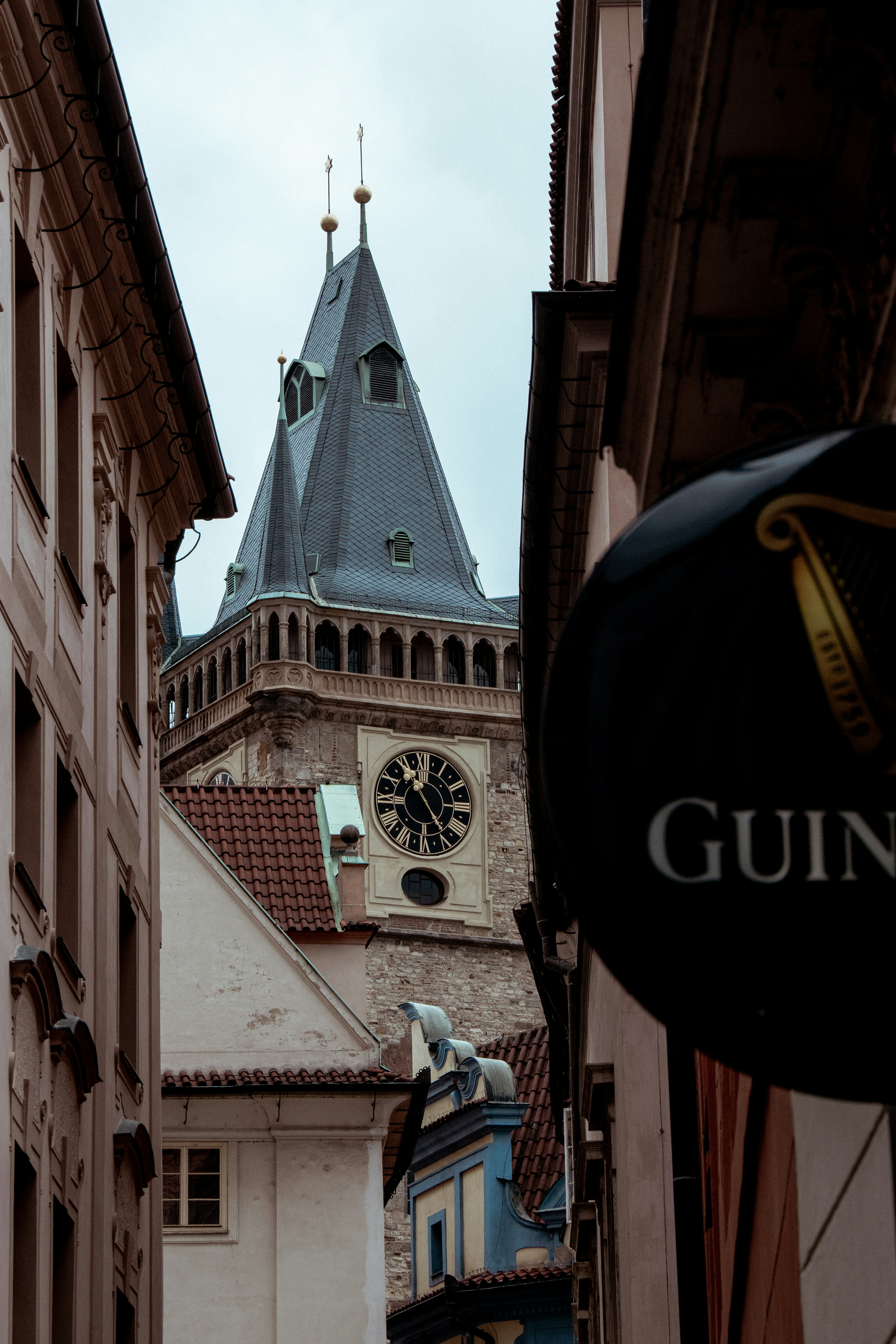 Gothic Clocktower Rising Over a Cobblestoned Alleyscape