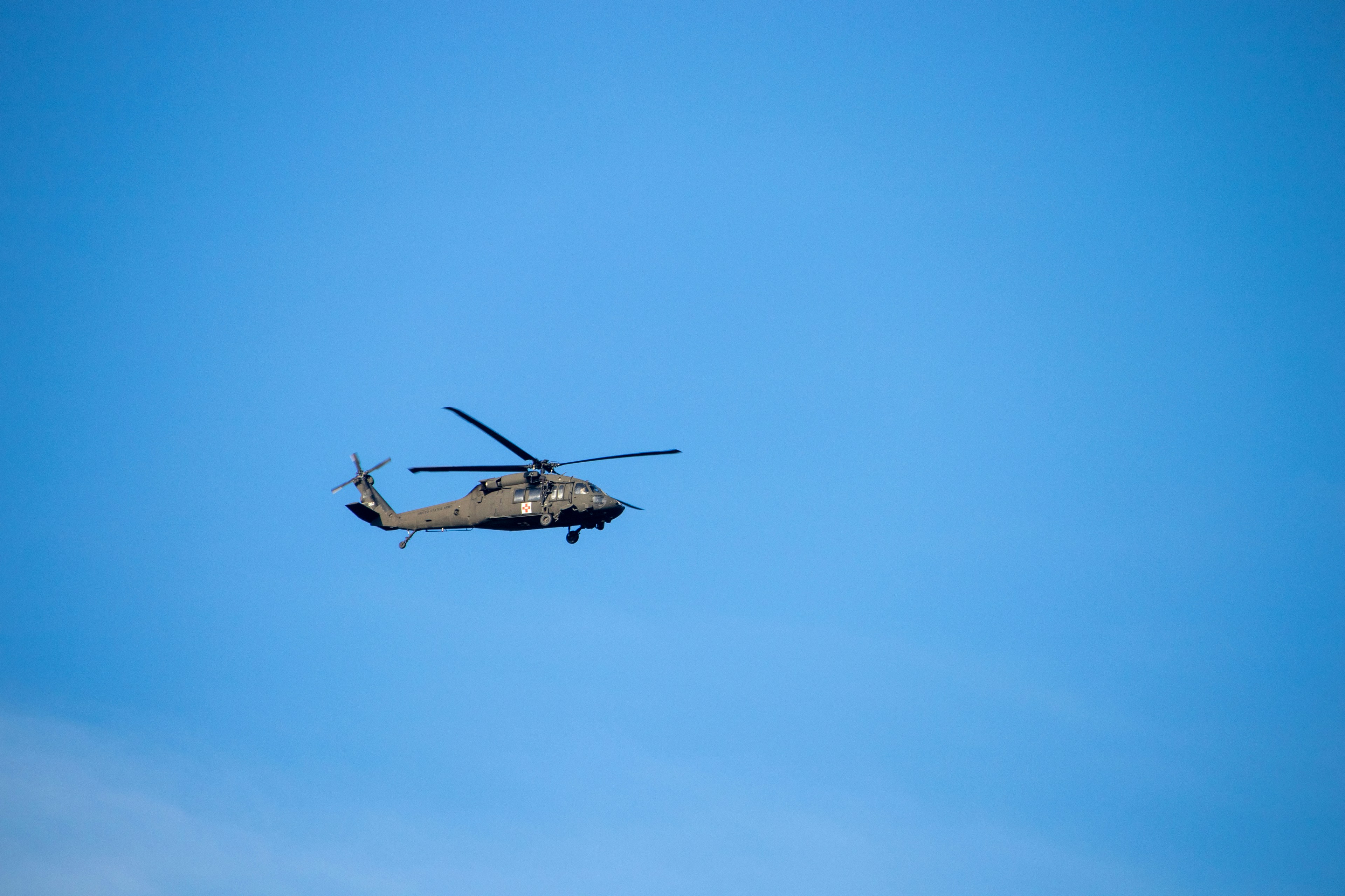A military helicopter flying through a blue sky photo – Free Orange ...