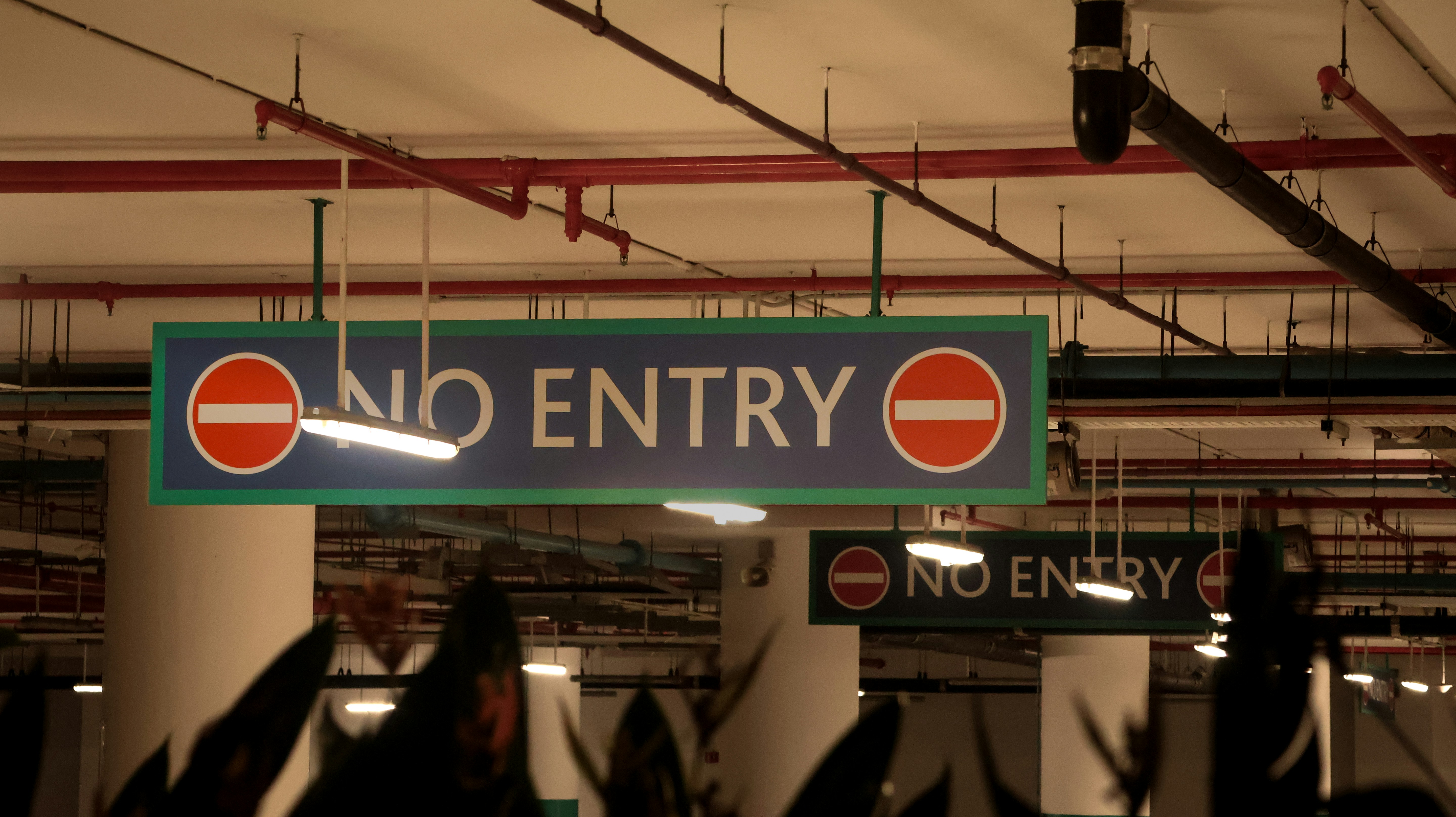A no entry sign hanging from the ceiling of a building photo – Free ...