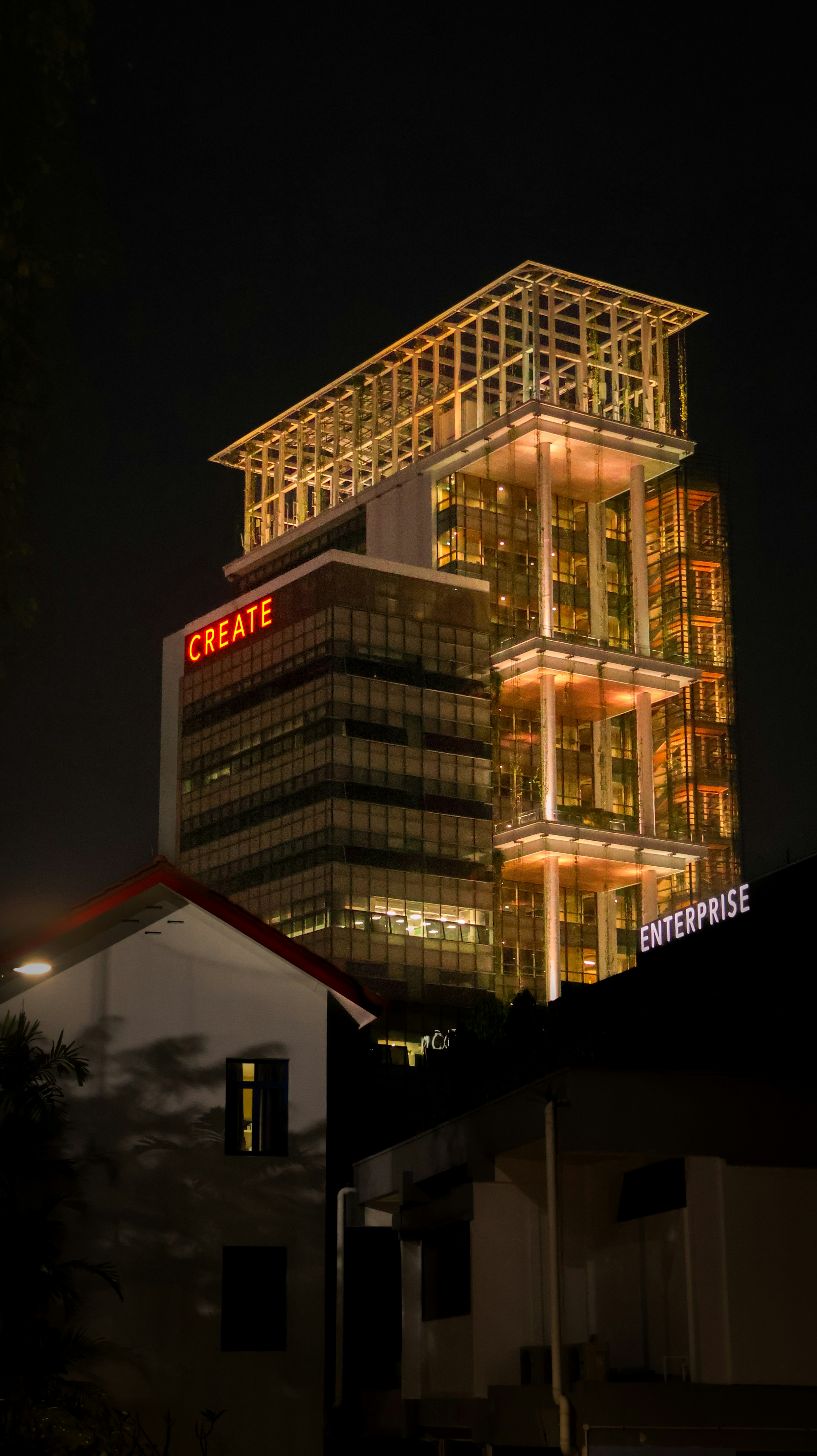 A tall building with a lit up sign on top of it photo – Free Building ...