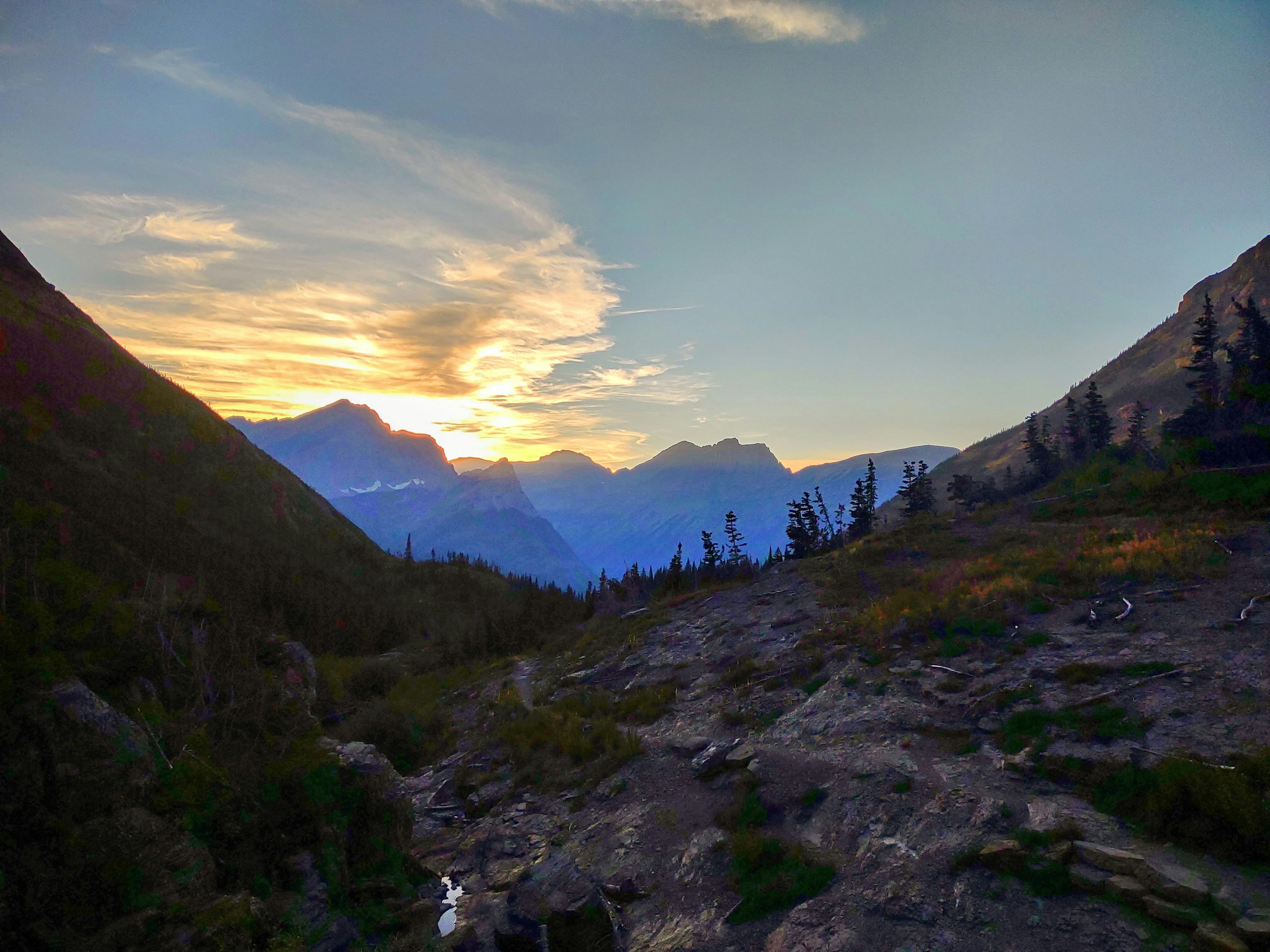 Sunlit Ridge Overlook at Distant Snow-Capped Peaks
