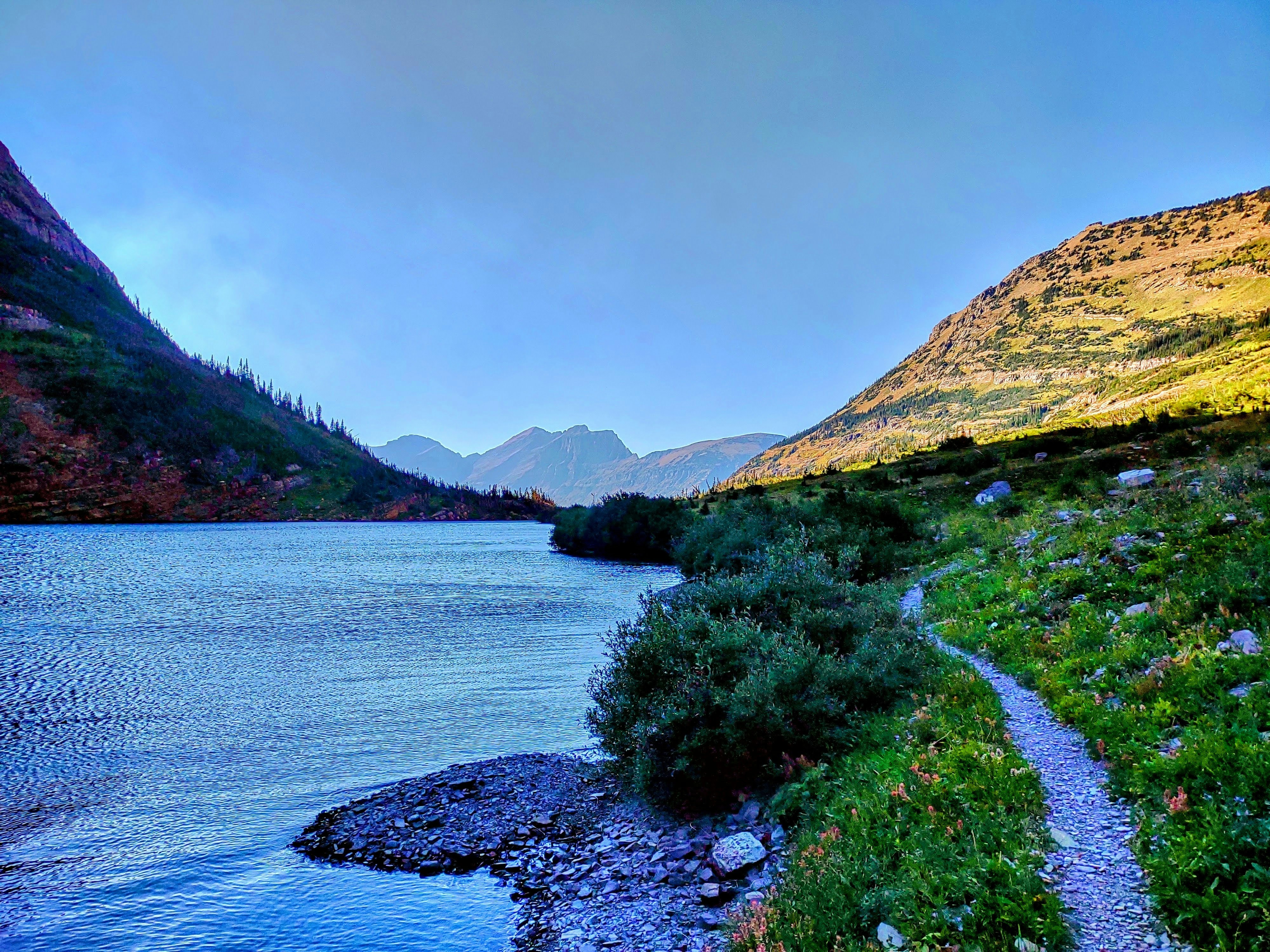 Sunlit Alpine Path Framing a Quiet Glacier-Blue Lake