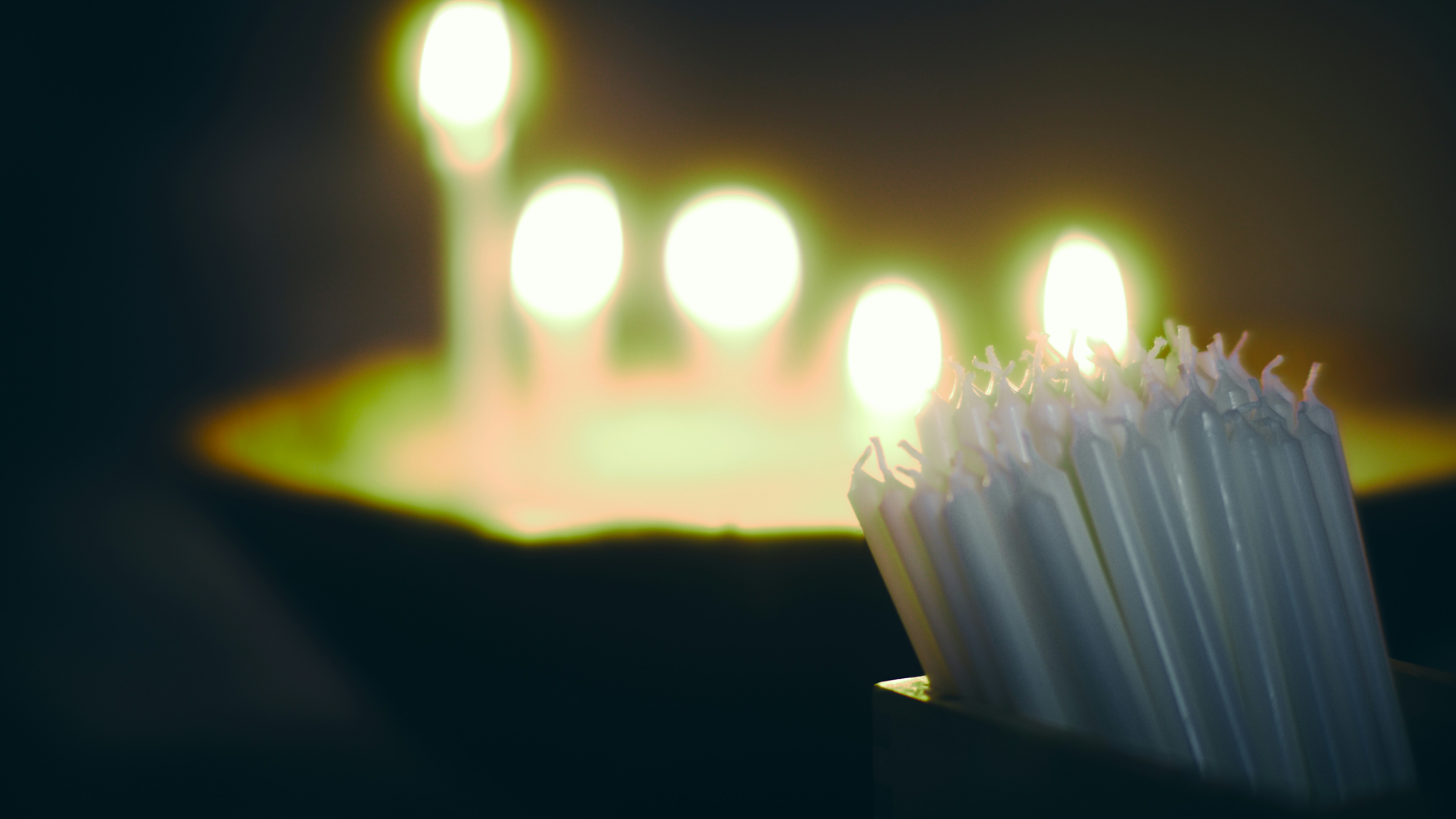 Candlelit Birthday Glow: Close-up of a Birthday Candle's Flame and Whisk-Like Wicks