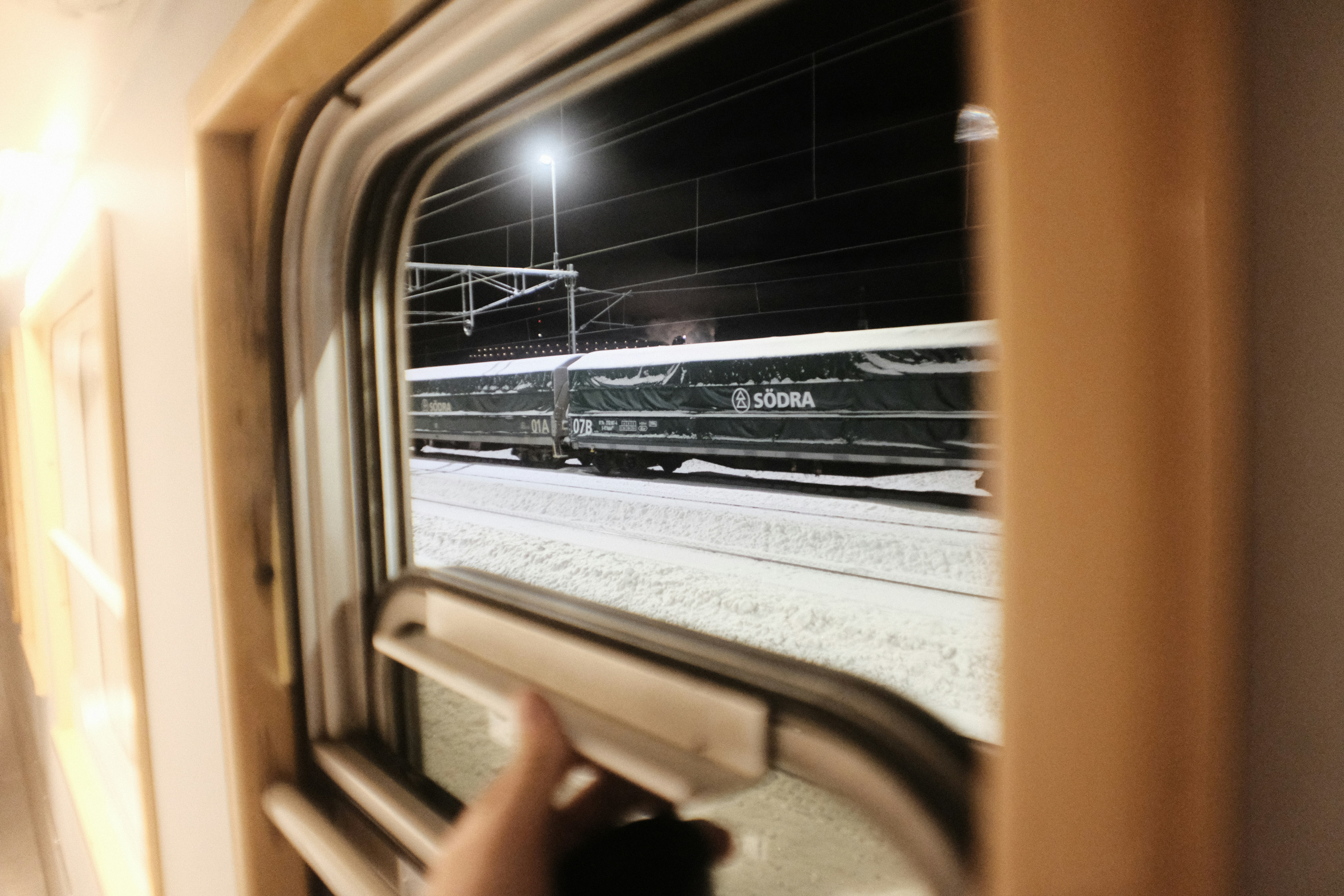A person looking out a train window at a train photo – Free Train Image ...