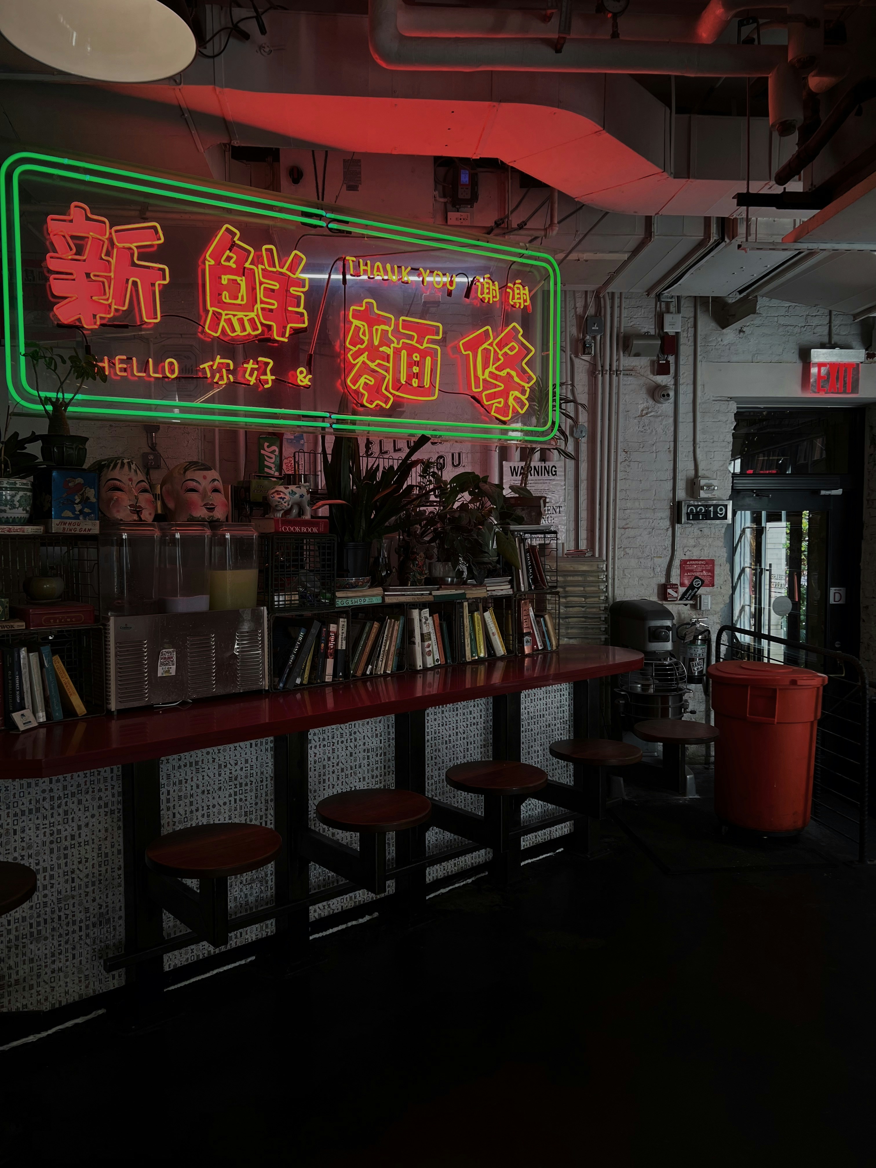 Neon Nook: Books, Barstools, and a Glowing Sign