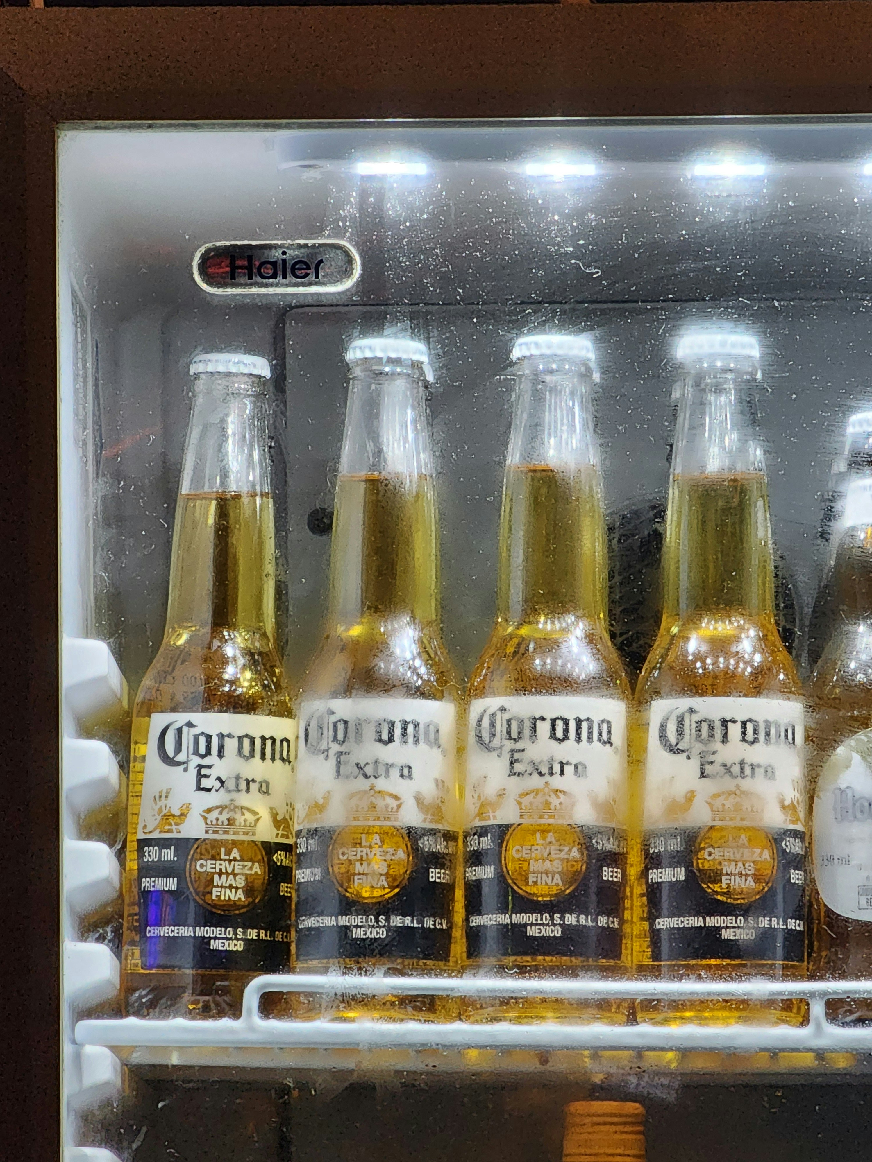 A refrigerator filled with lots of bottles of beer photo – Free Alcohol ...